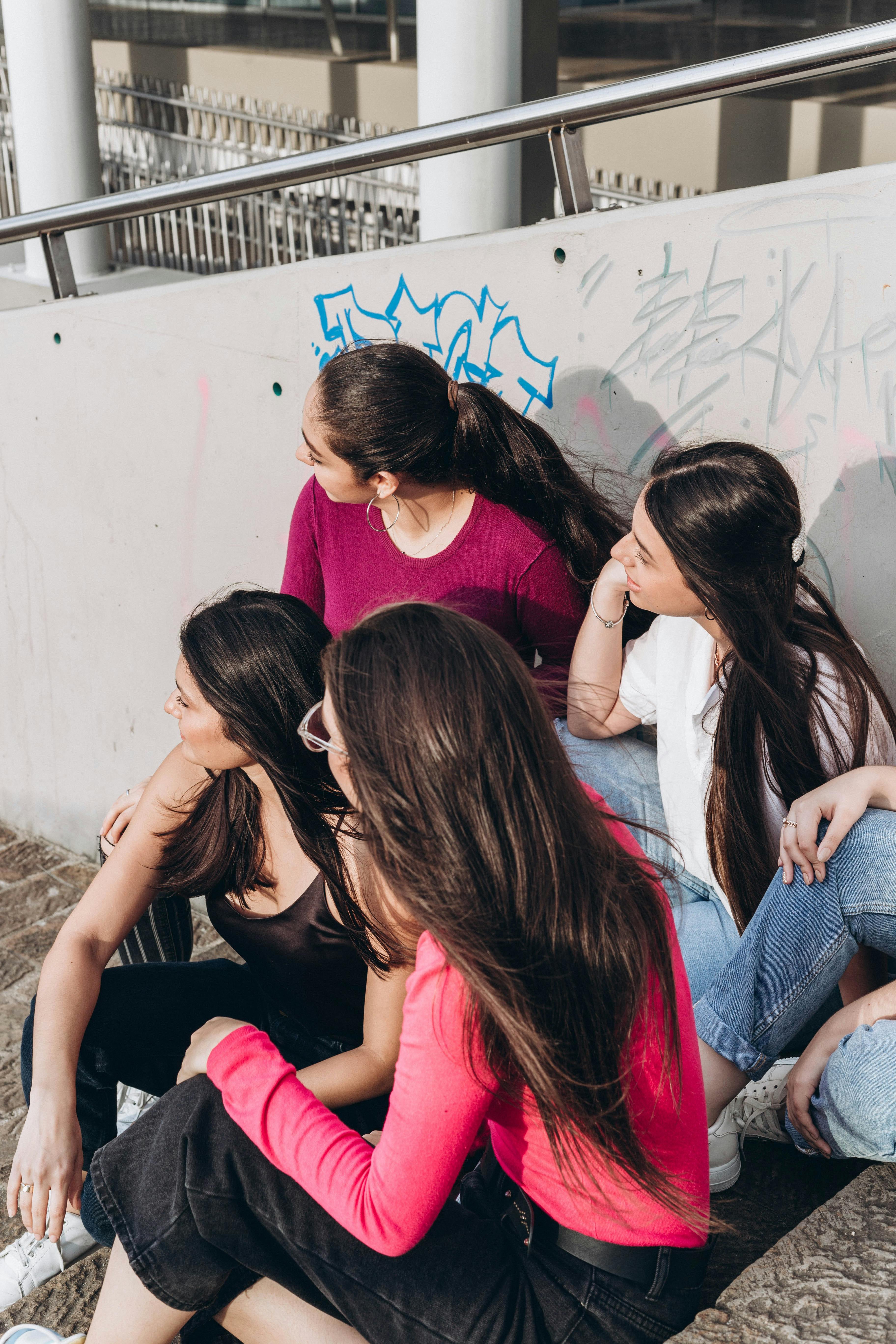 A Group of Schoolgirls and Schoolboys in Uniforms Sitting on Steps ...