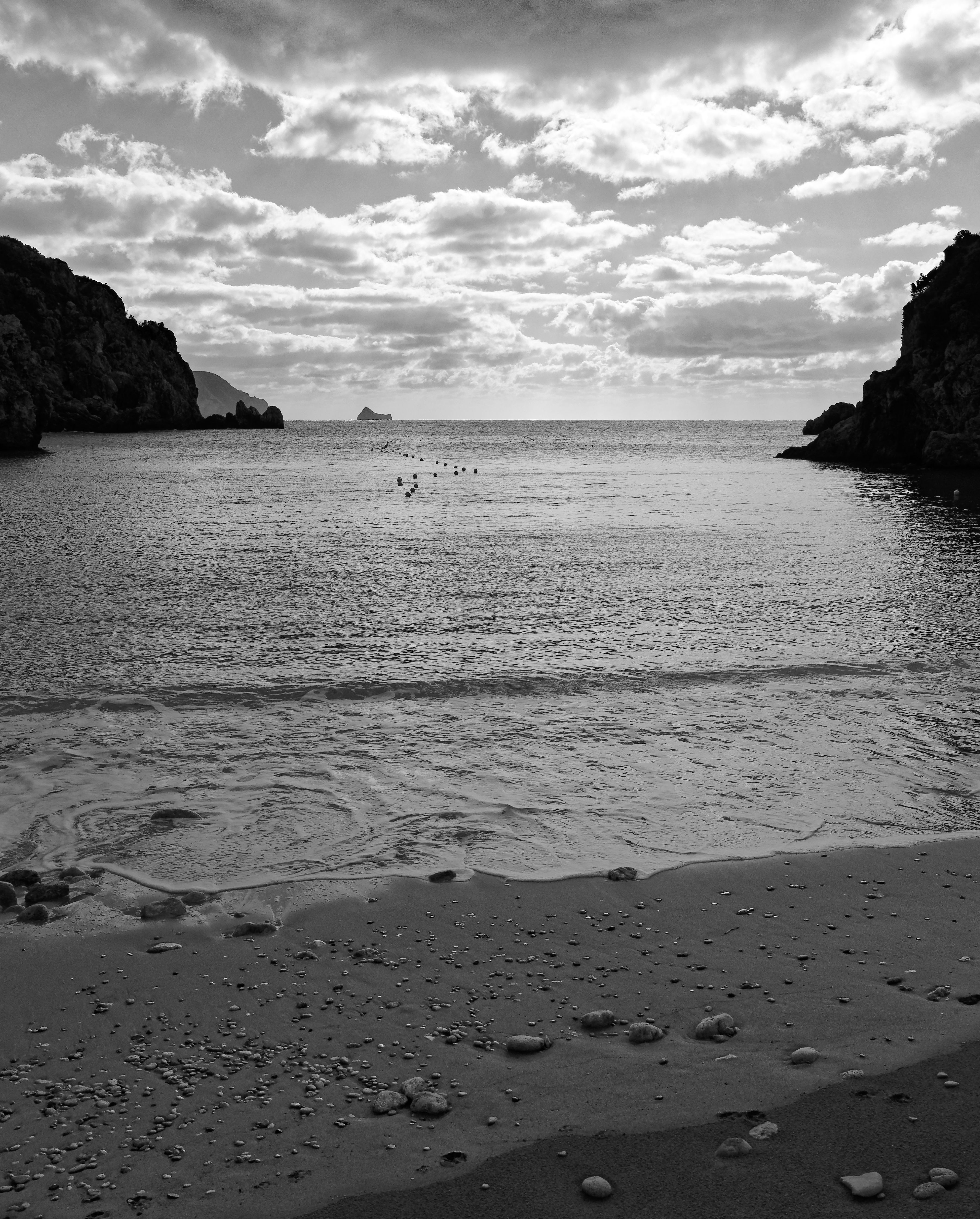 Grayscale Photo of an Islet · Free Stock Photo