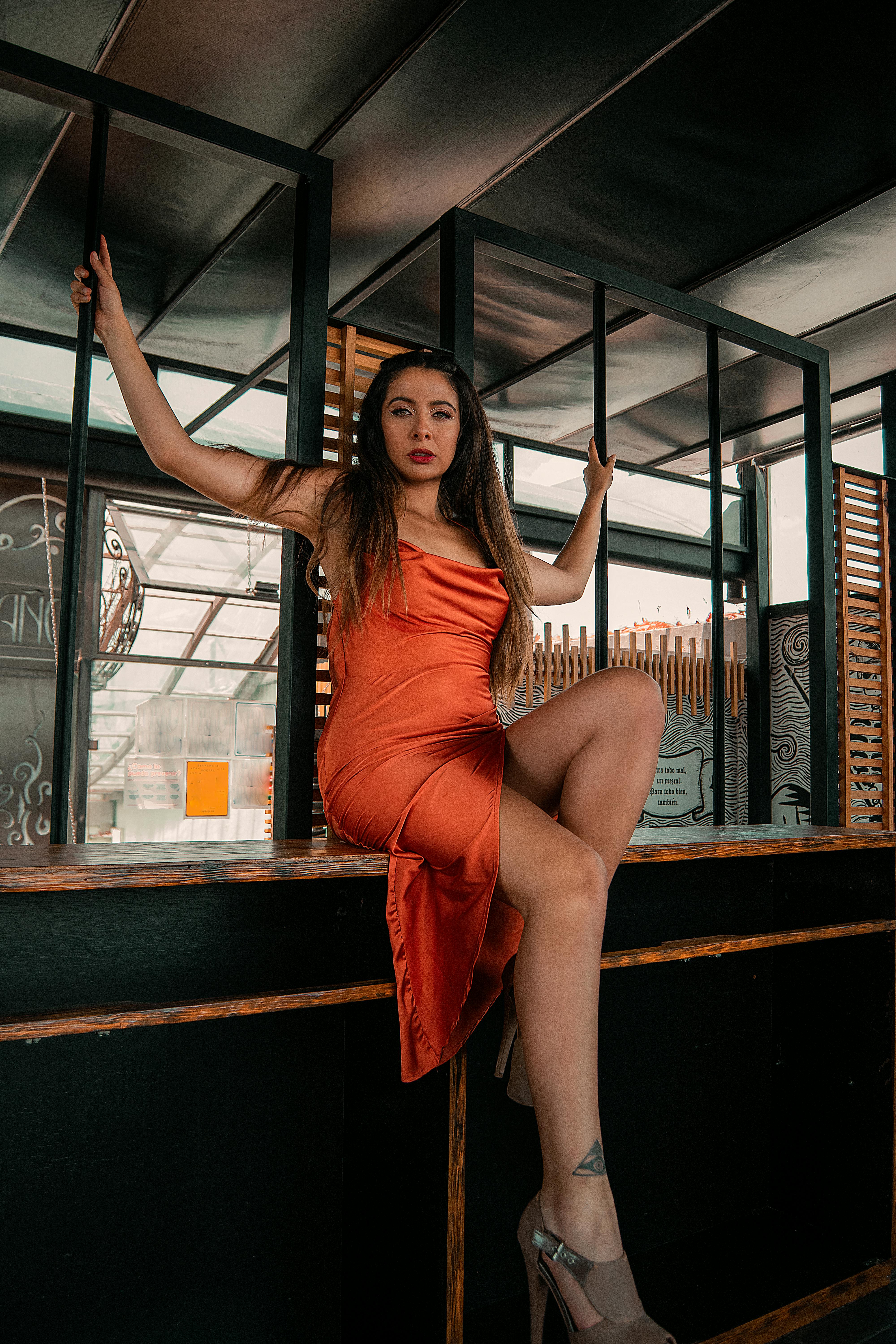 A Pretty Woman in an Orange Dress · Free Stock Photo