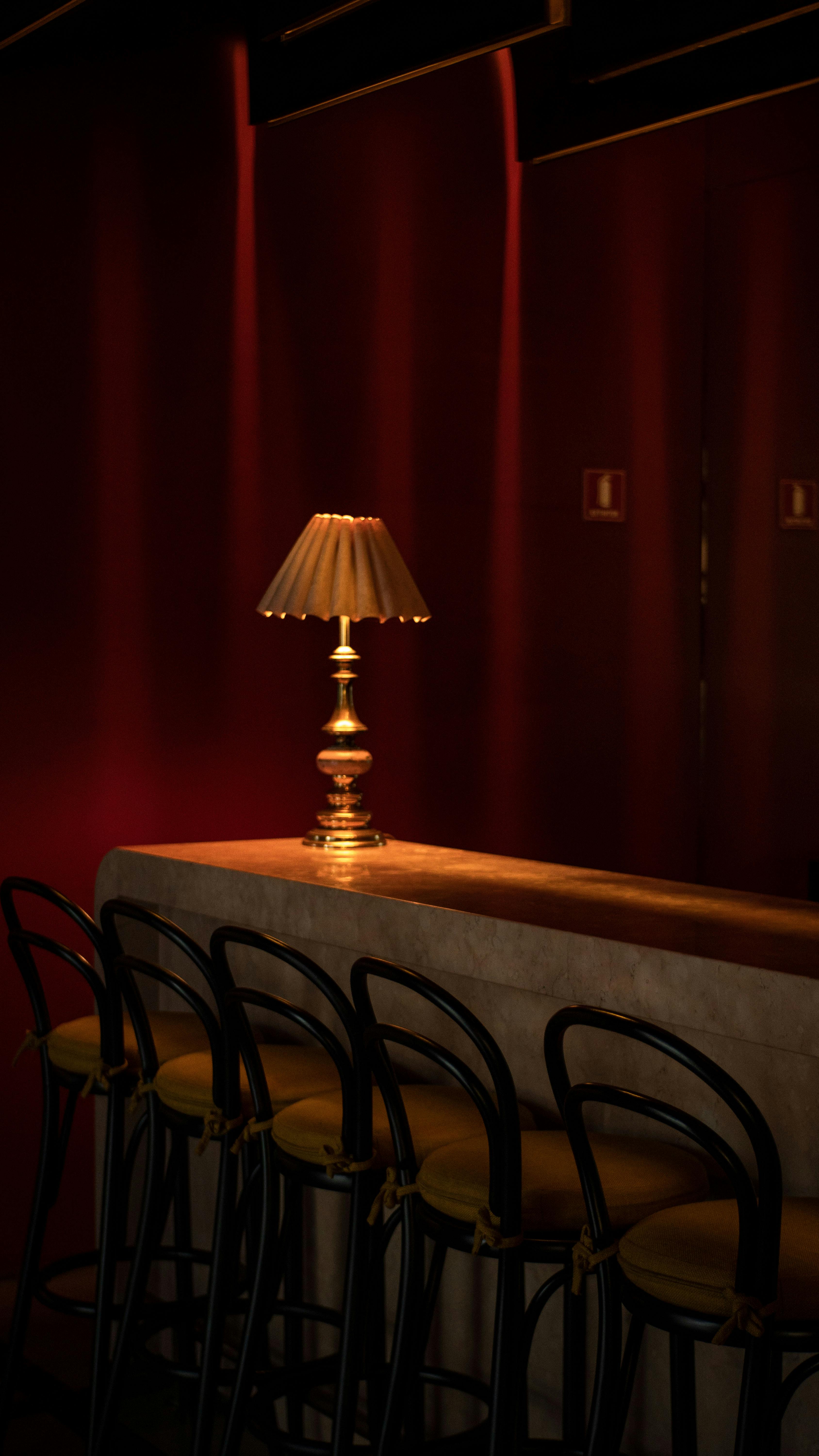 Lamp near Chairs and Wall · Free Stock Photo