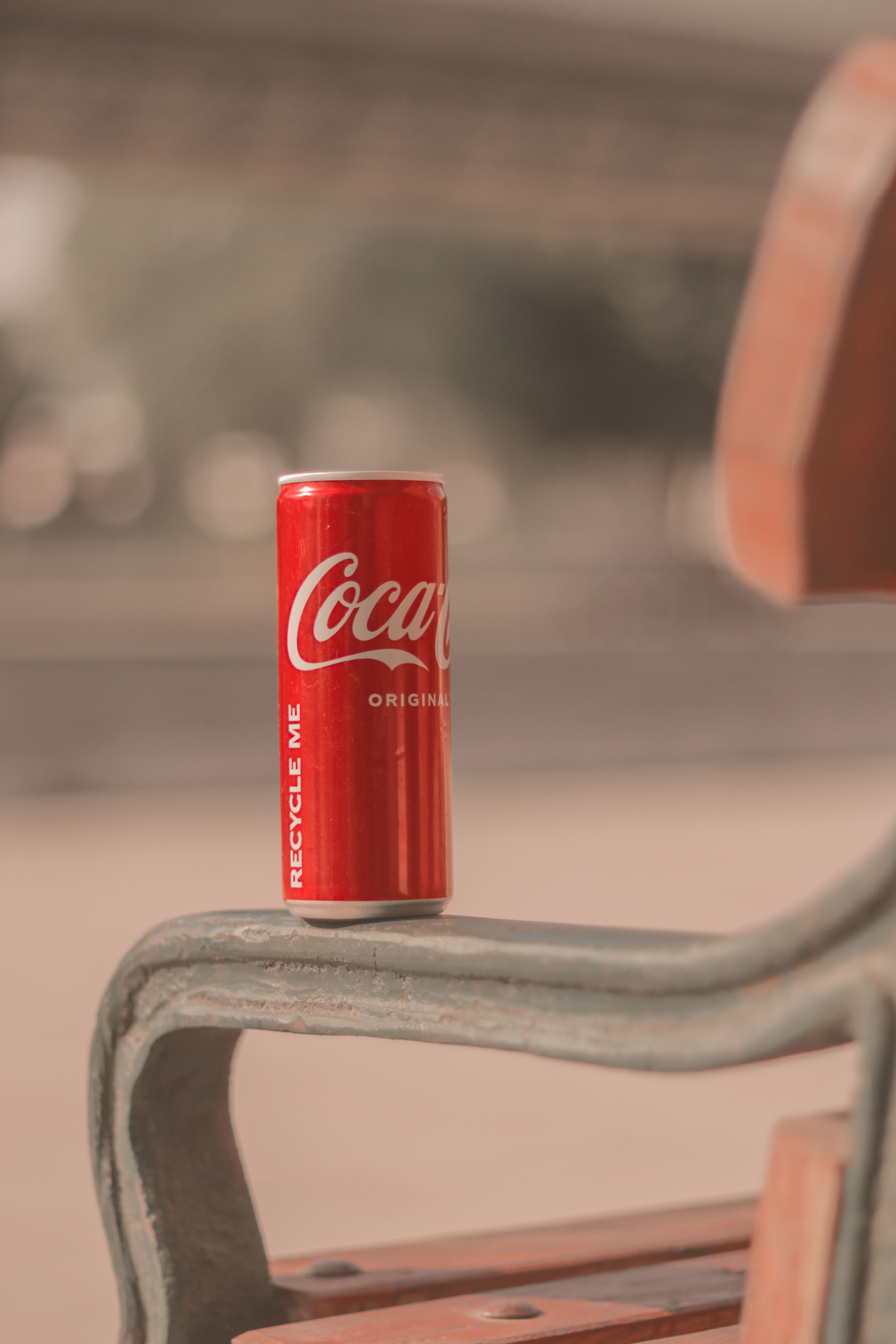 Close-up of a Coca-Cola on a Bench · Free Stock Photo