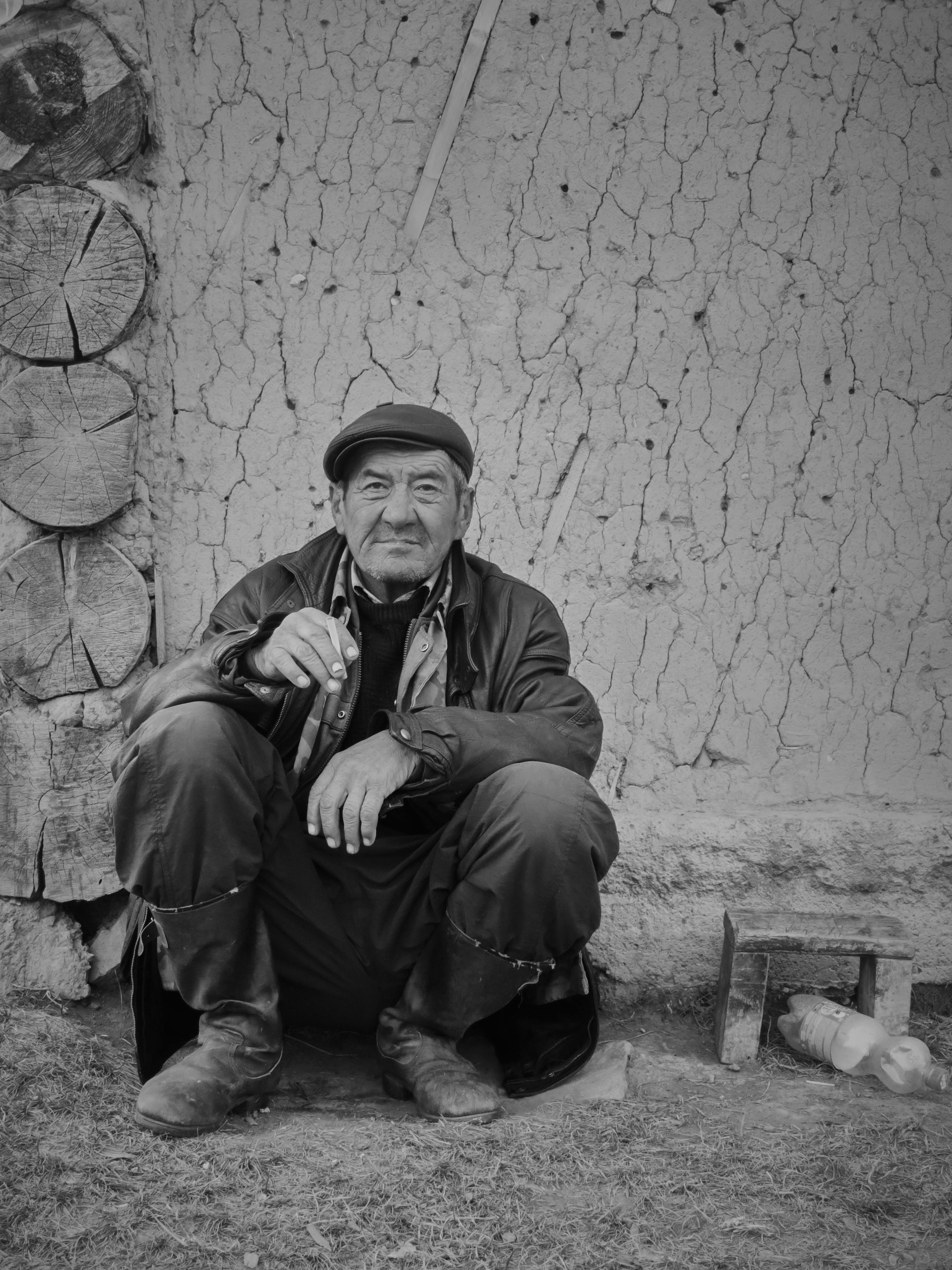 Old Man near Ornate Traditional House · Free Stock Photo