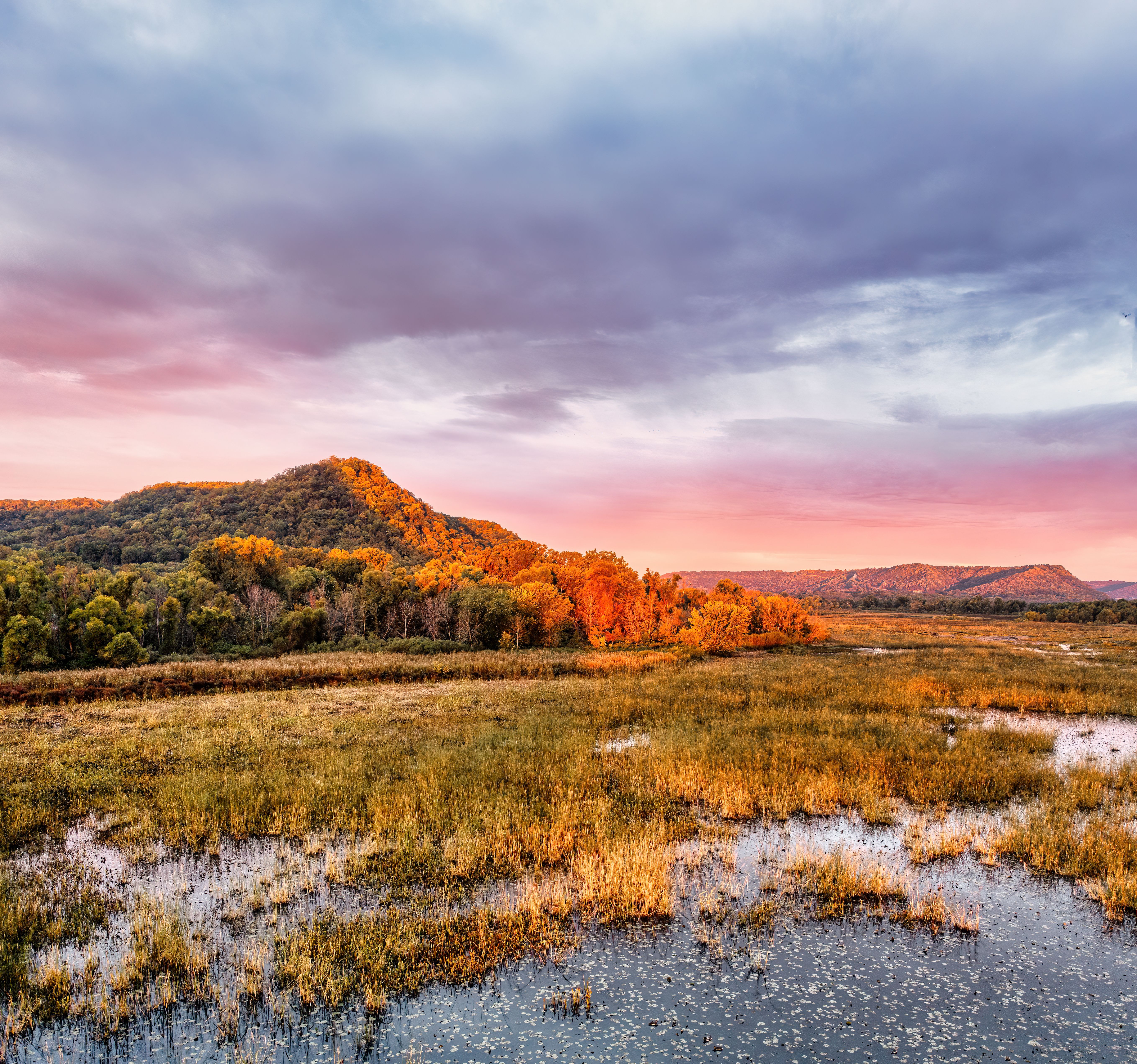 Landscape of Hills and Wetlands at Sunset · Free Stock Photo