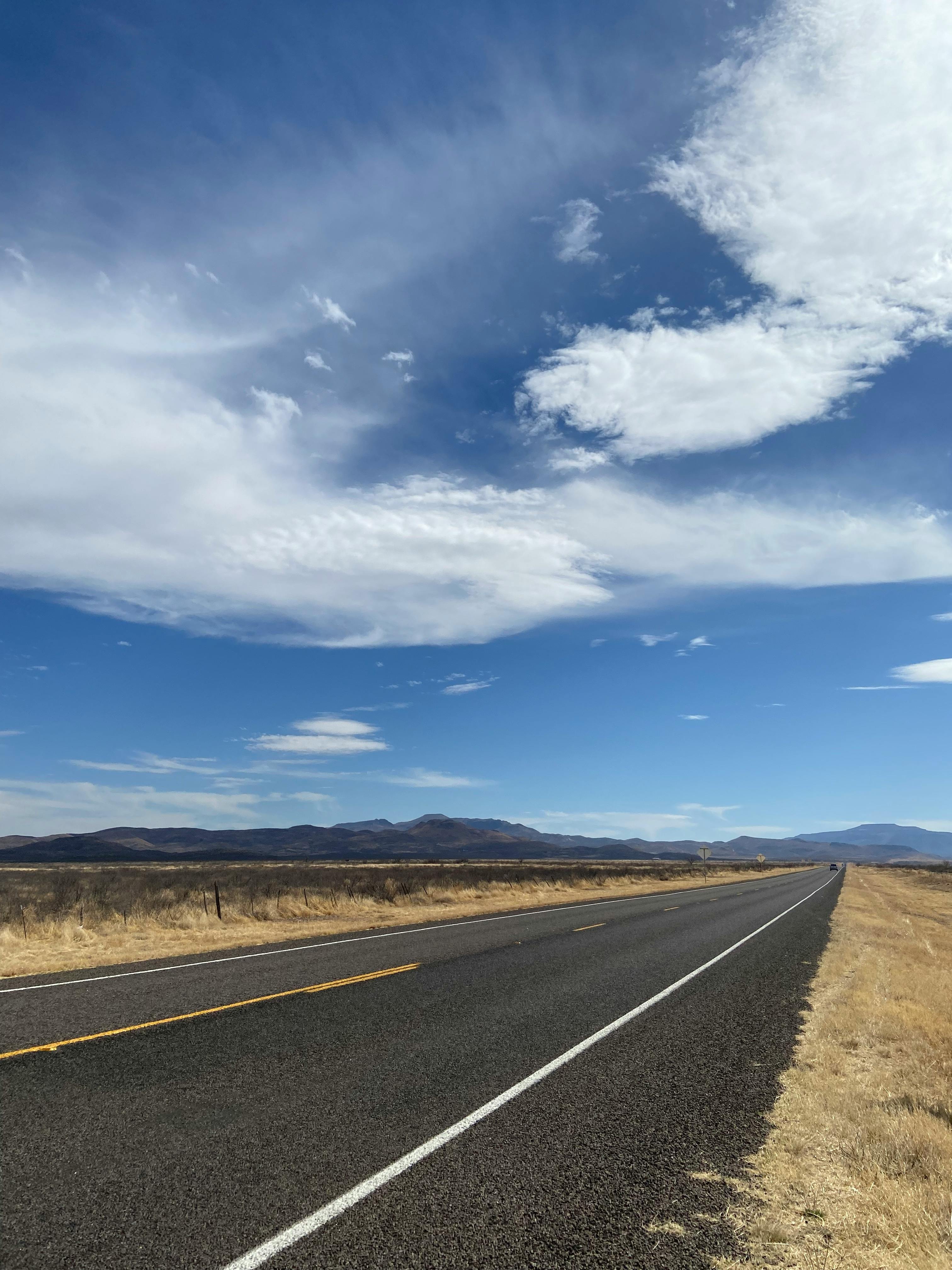 Asphalt Road Between Grass Field · Free Stock Photo
