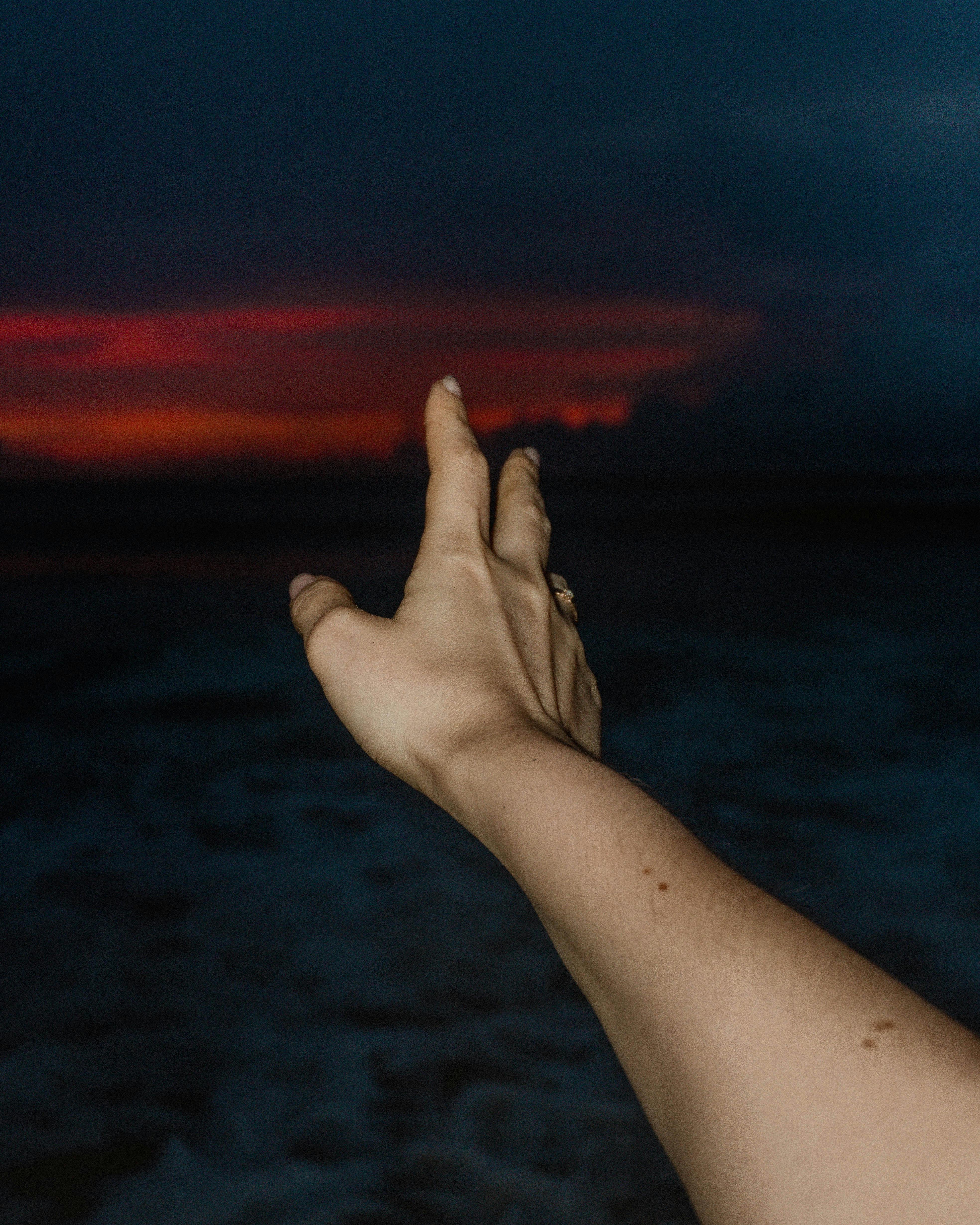 Hand Pointing at Sunset · Free Stock Photo
