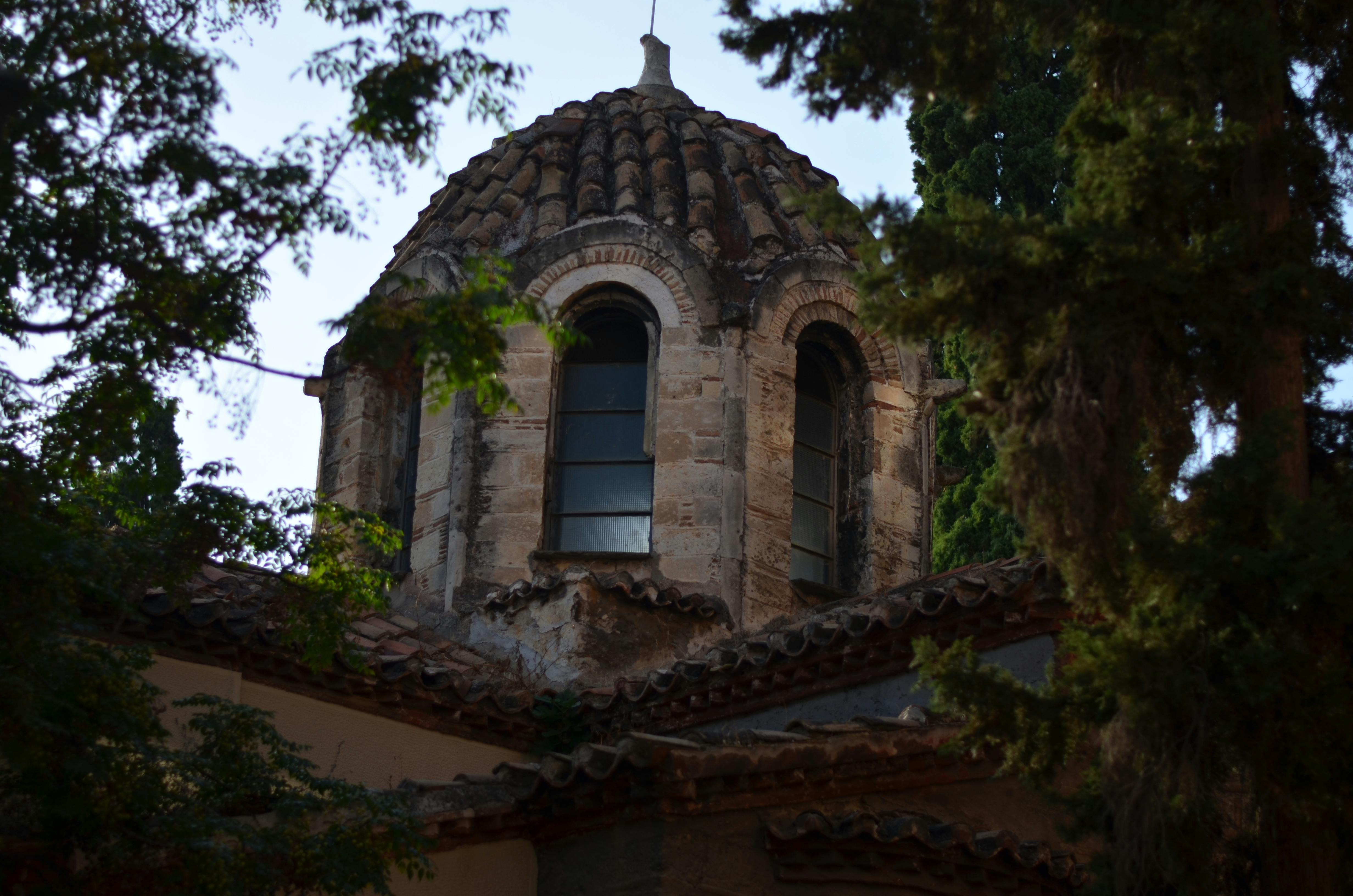 Photo of a Building Near Tree Leaves · Free Stock Photo