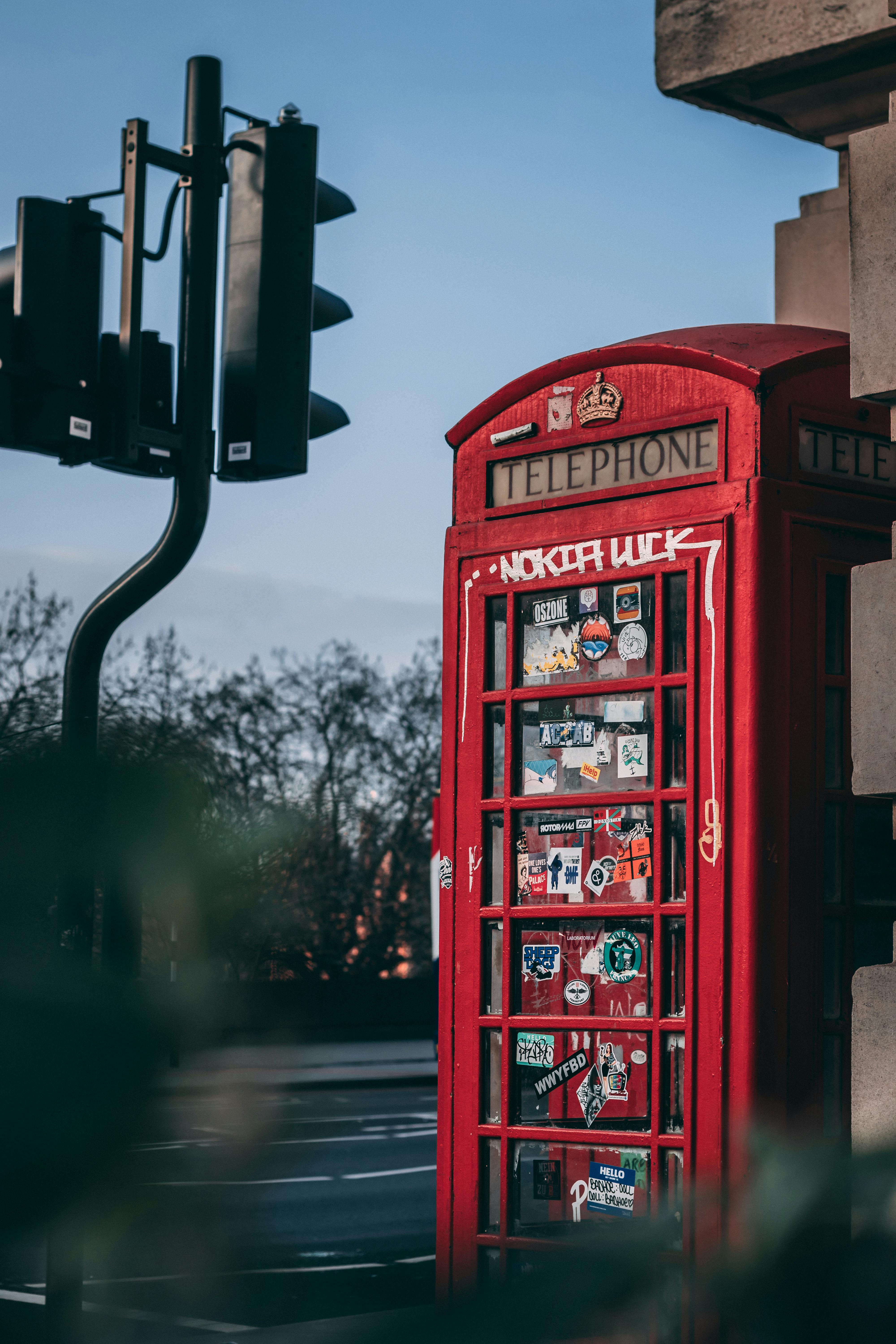 A Phone Booth with Reflecting Neon Sign · Free Stock Photo