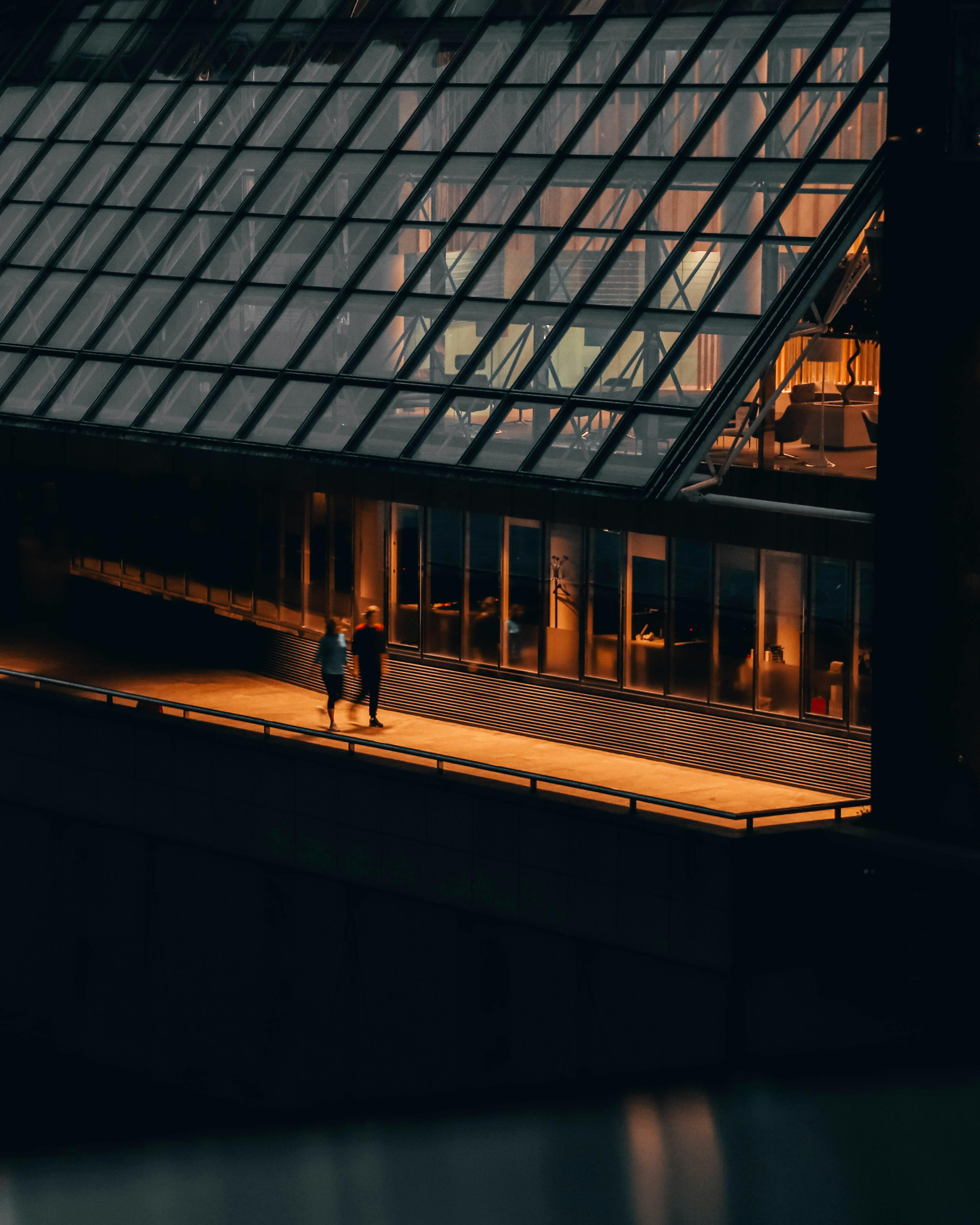People Walking Beside the Building with Glass Ceiling · Free Stock Photo