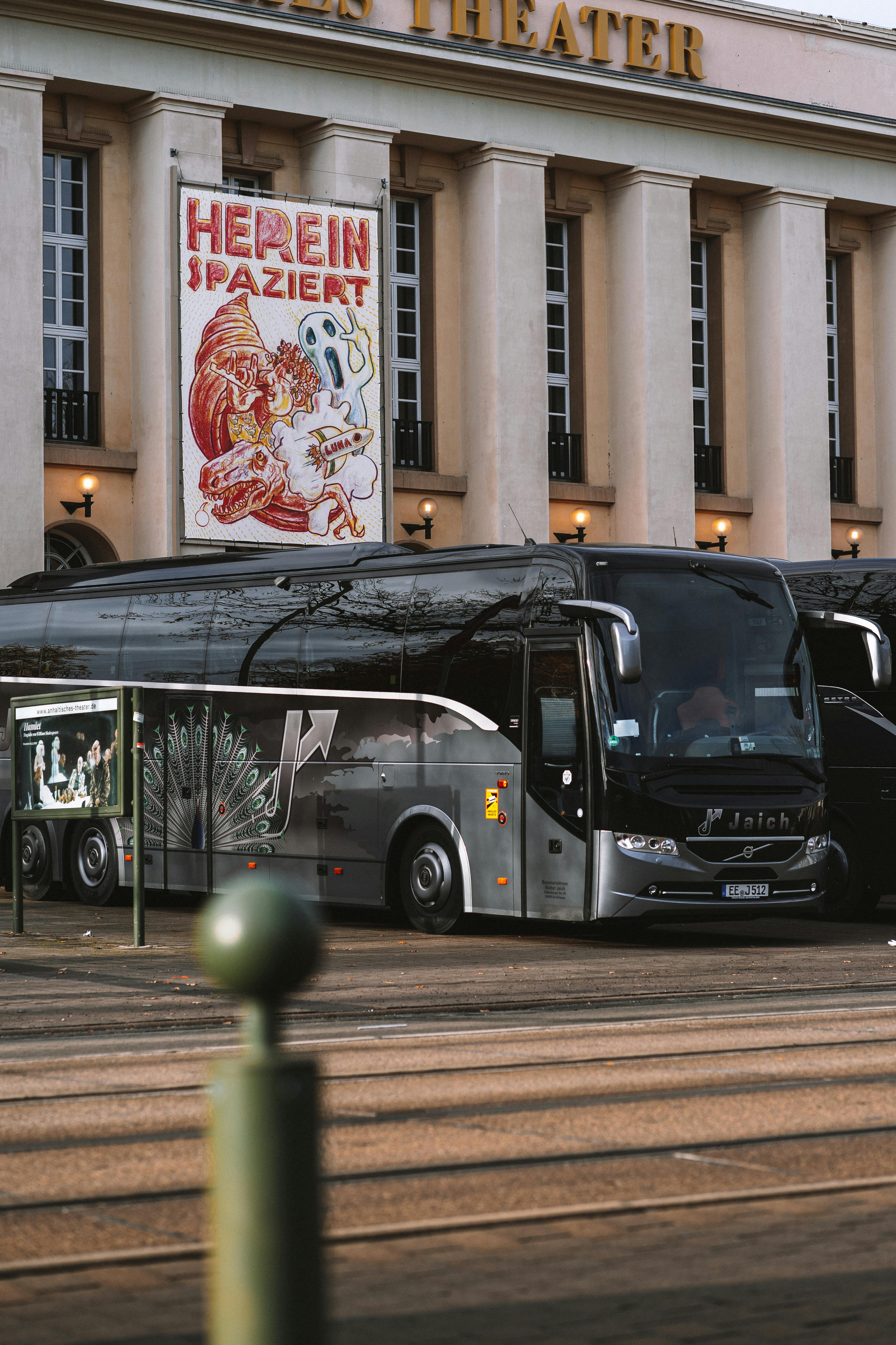 Black Buses in Front of a Theater Building · Free Stock Photo
