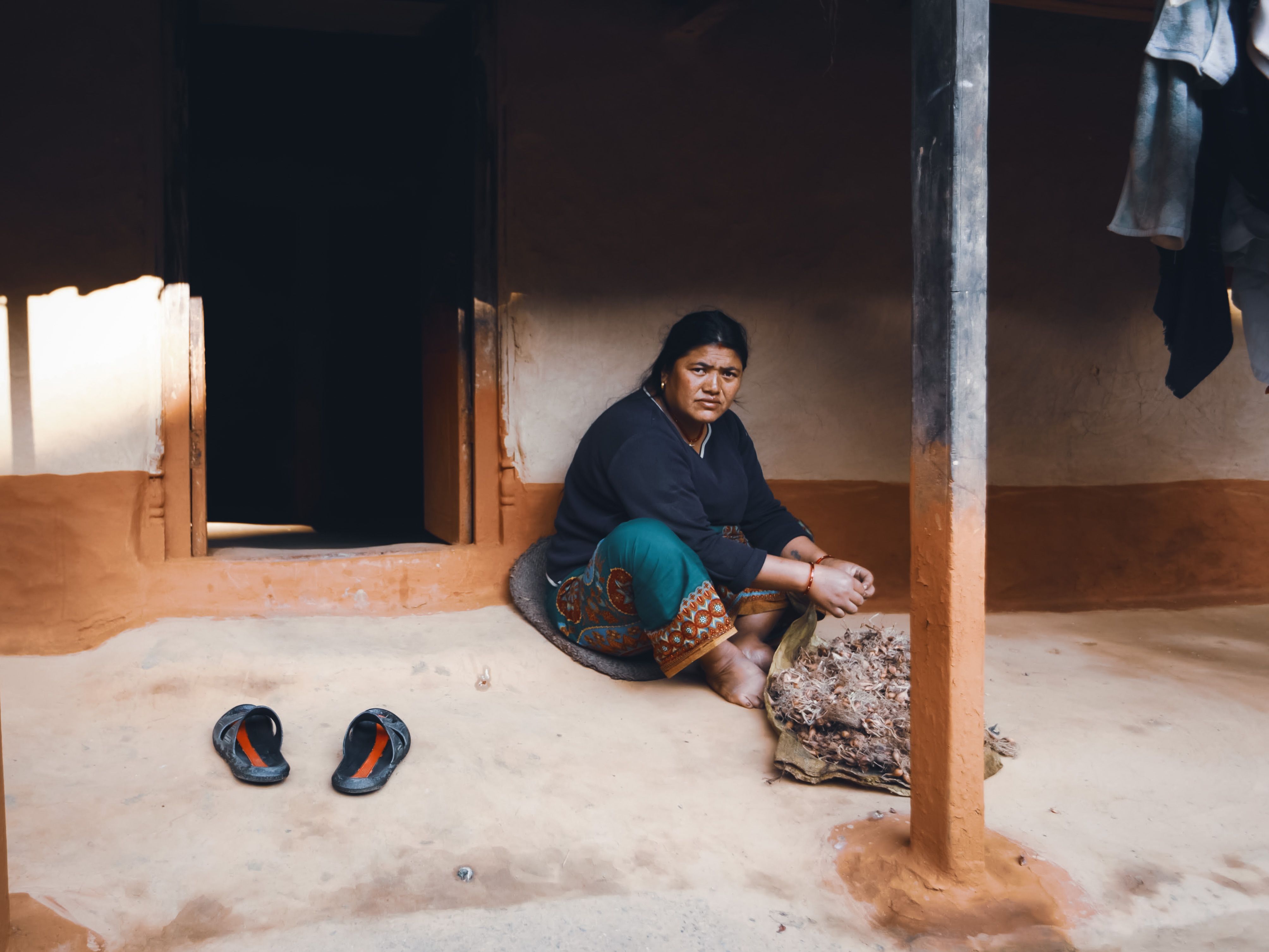 Native American Woman Sitting Outside her House · Free Stock Photo