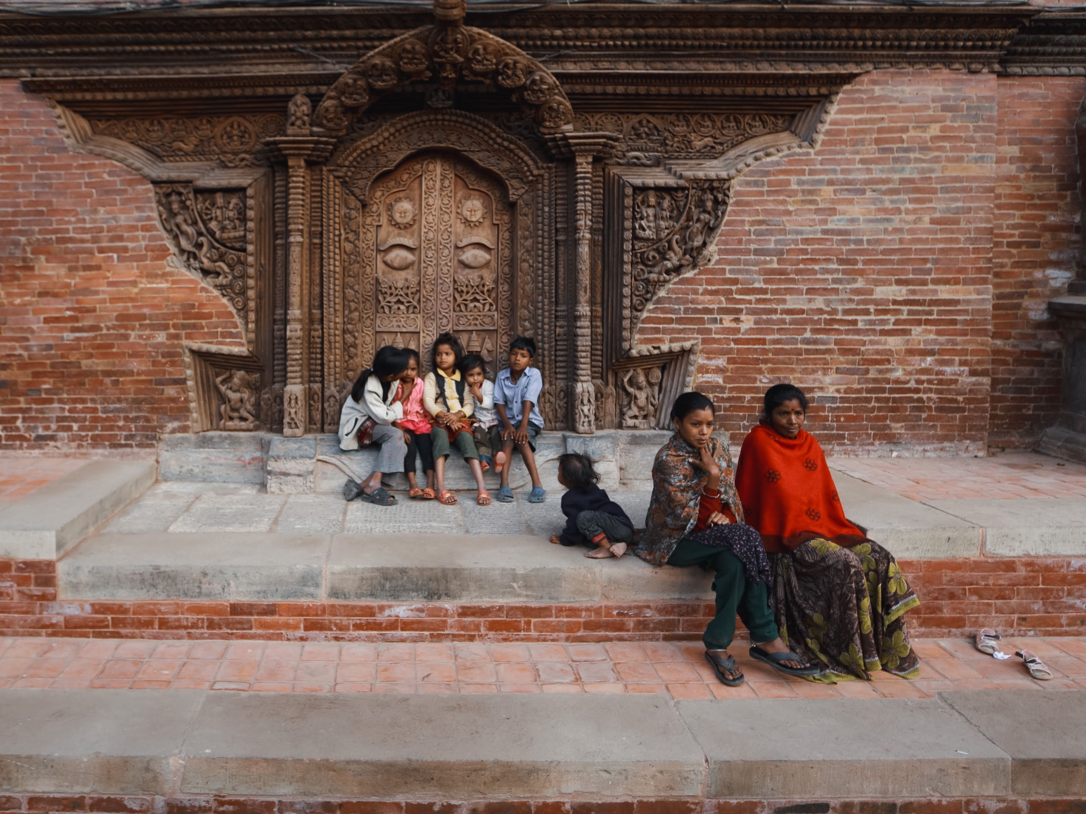 Group of Happy People Sitting on a Pavement · Free Stock Photo