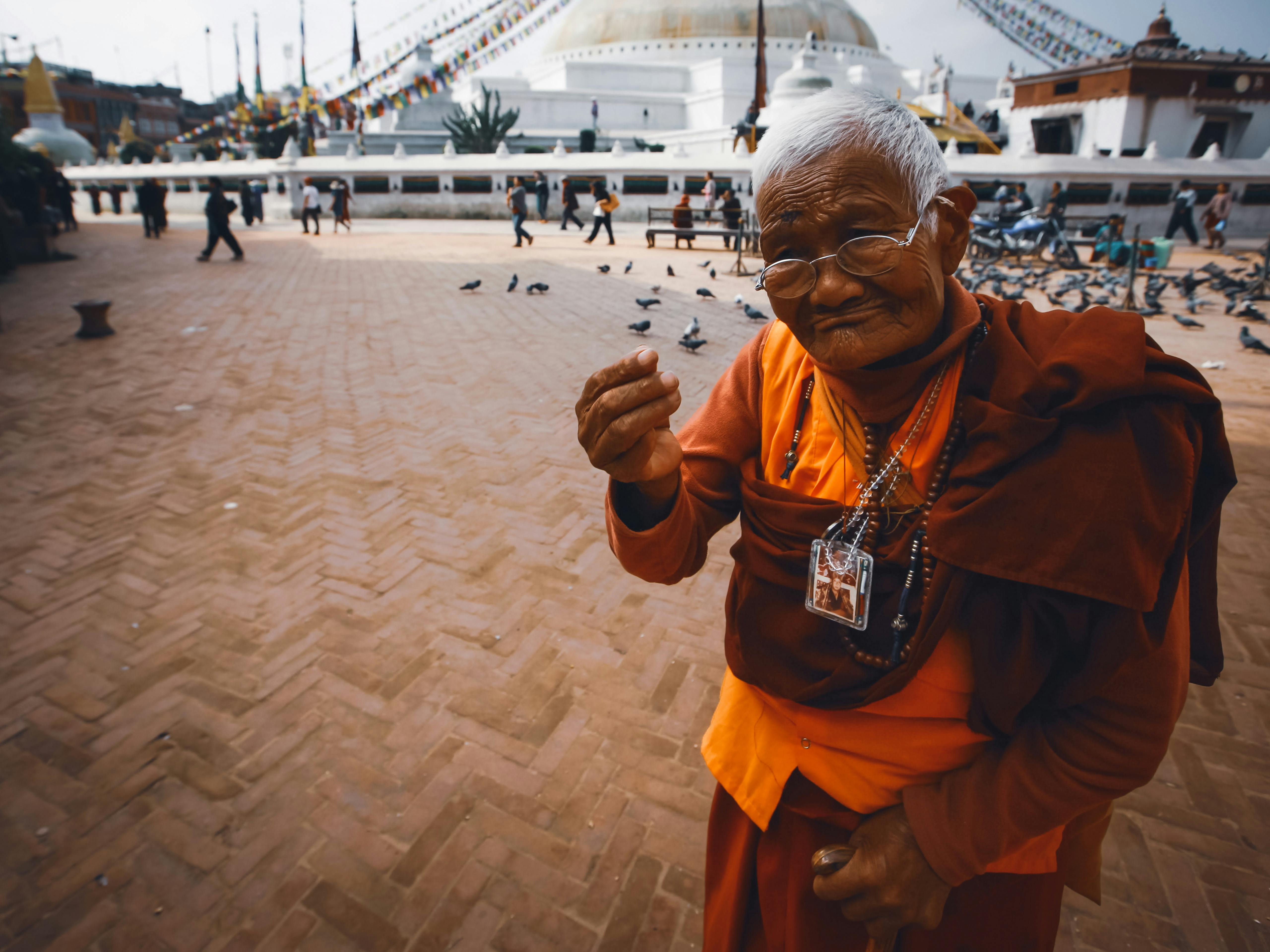 Elderly Monk with a Stick · Free Stock Photo