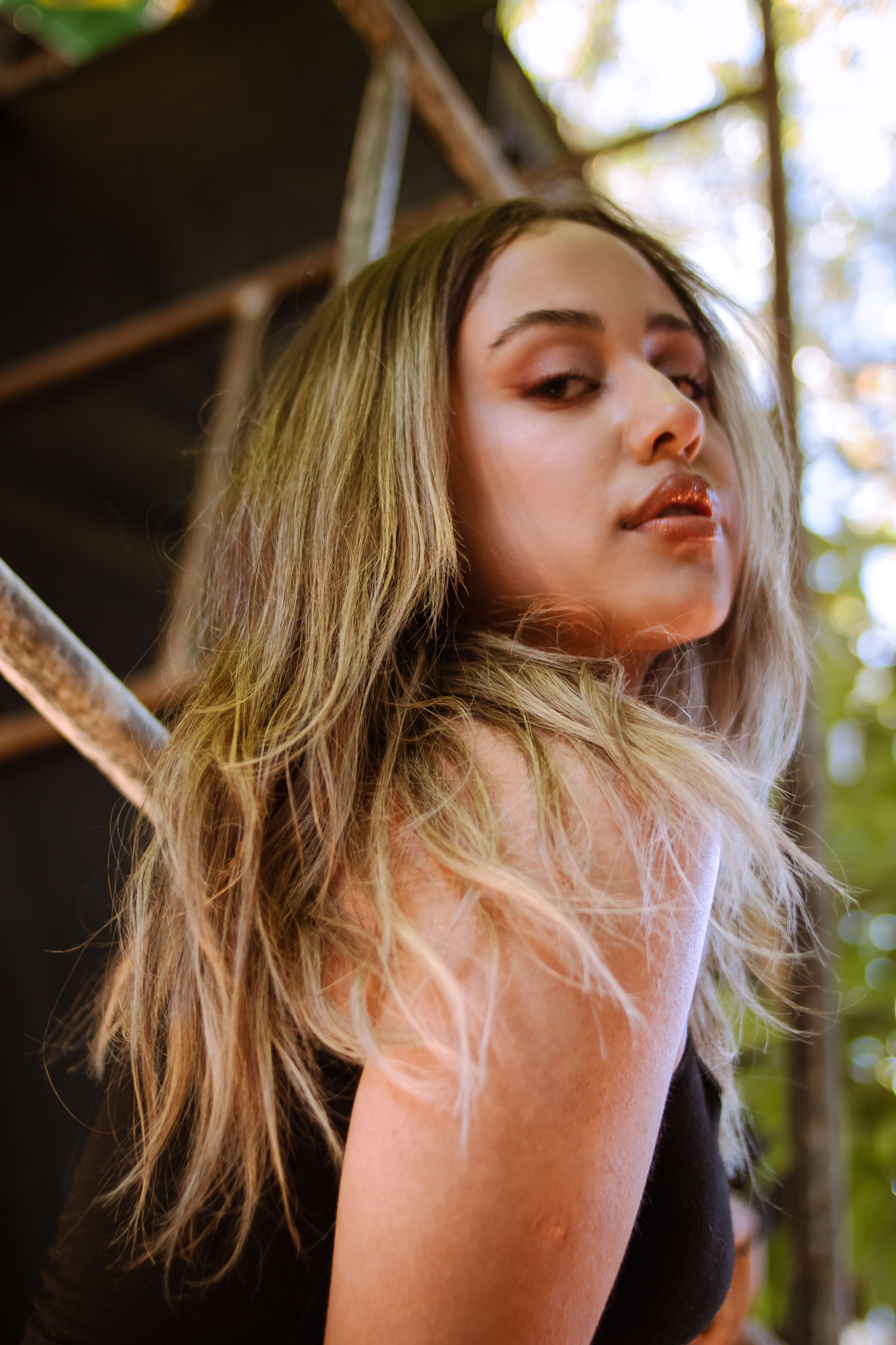 Blonde Woman Posing Beside the Metal Bars · Free Stock Photo