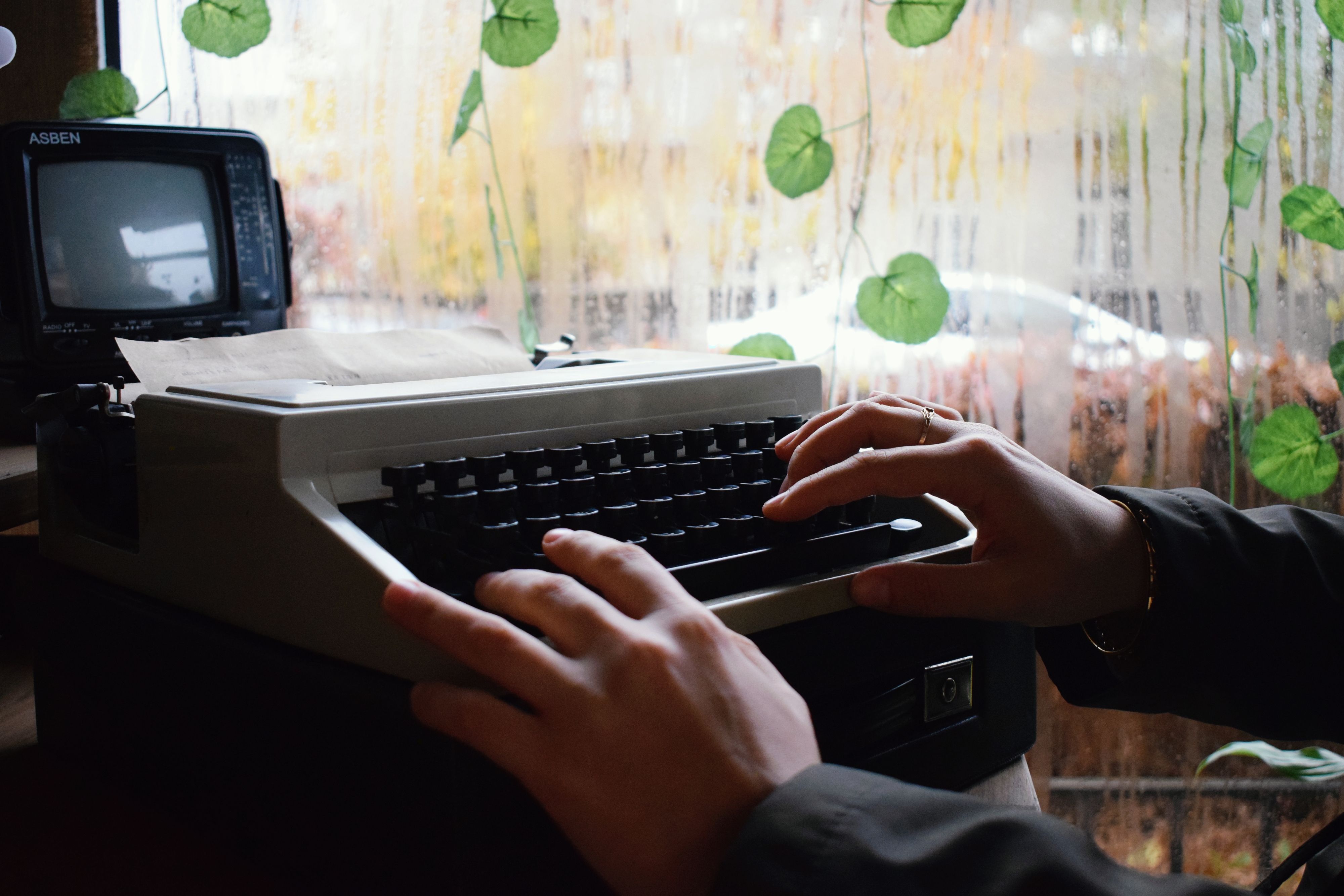 A Person Using a Typewriter · Free Stock Photo