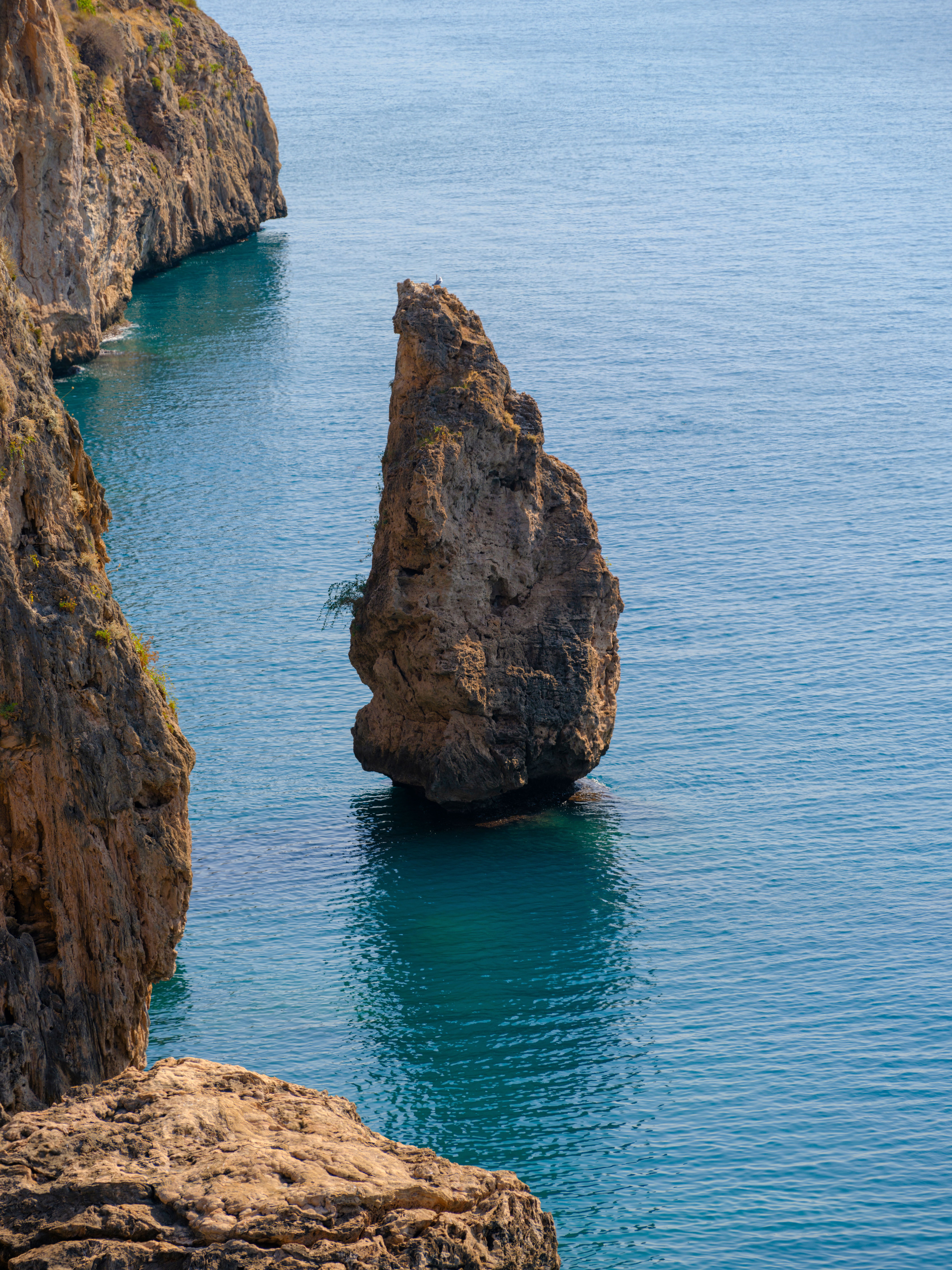 View of a Cliff and Rock Formations on a Shore · Free Stock Photo
