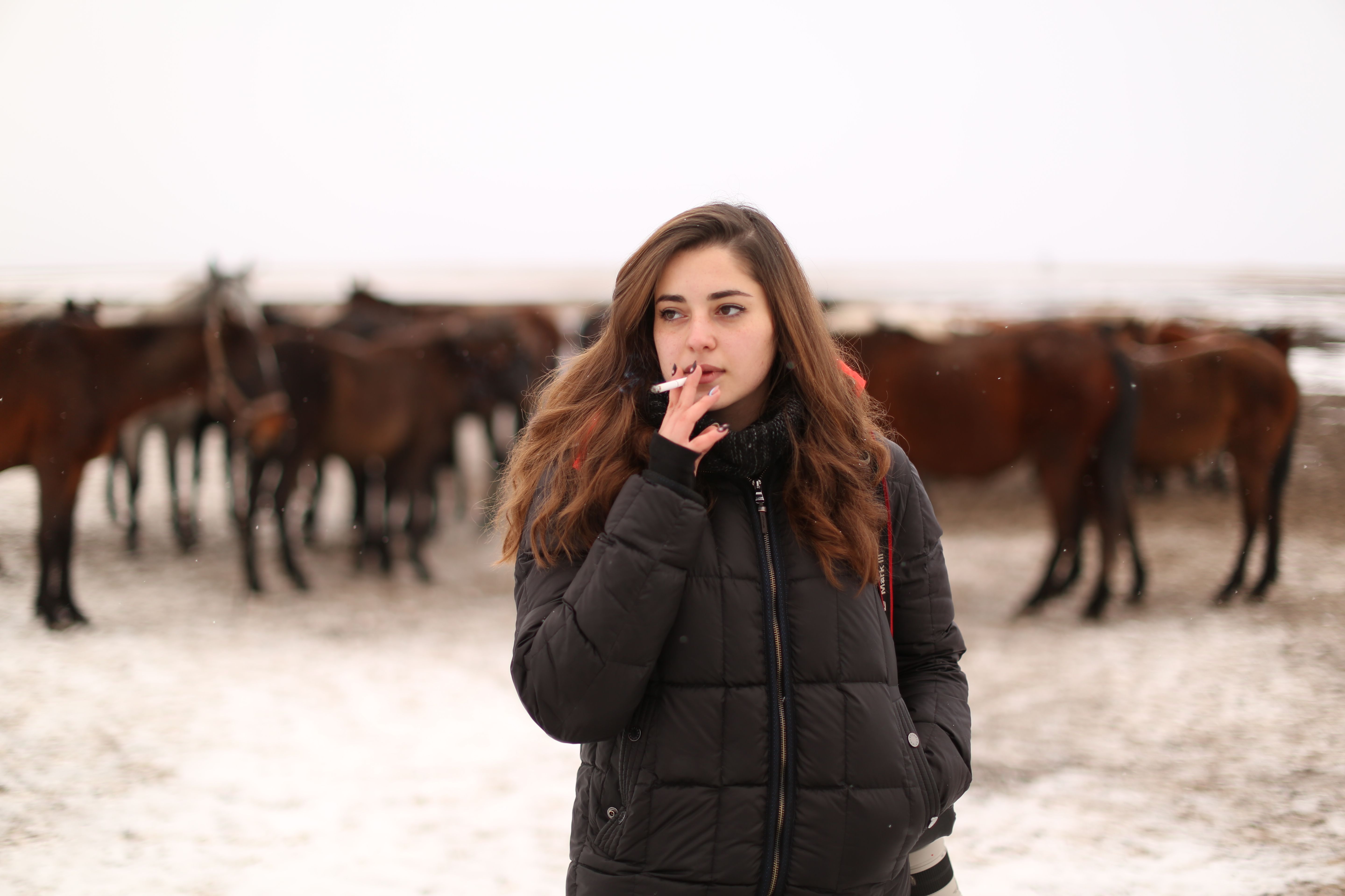 A Woman in a Black Jacket Smoking a Cigarette · Free Stock Photo