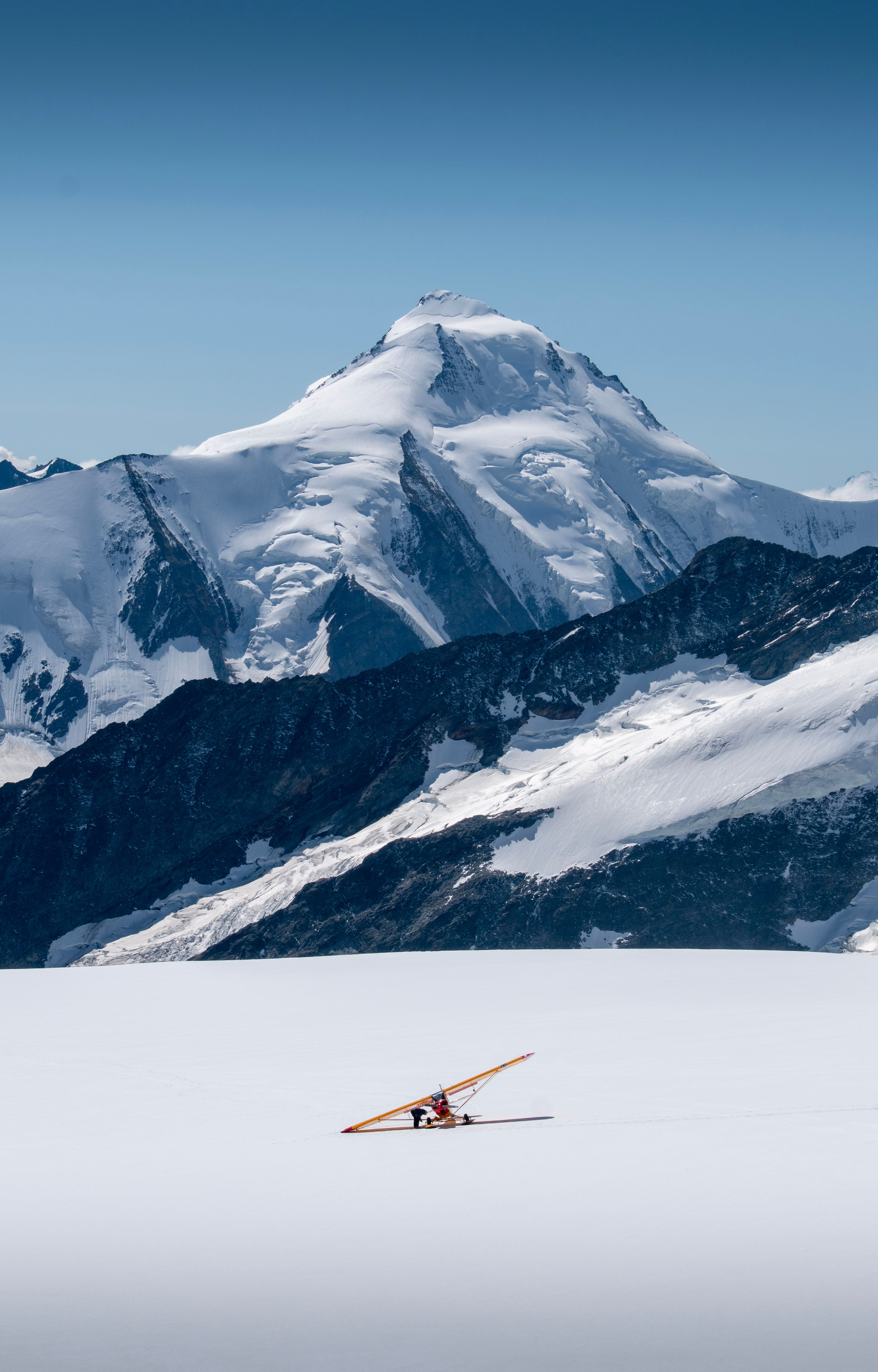 Airplane on Snow Covered Ground Near Snow Covered Mountains · Free ...