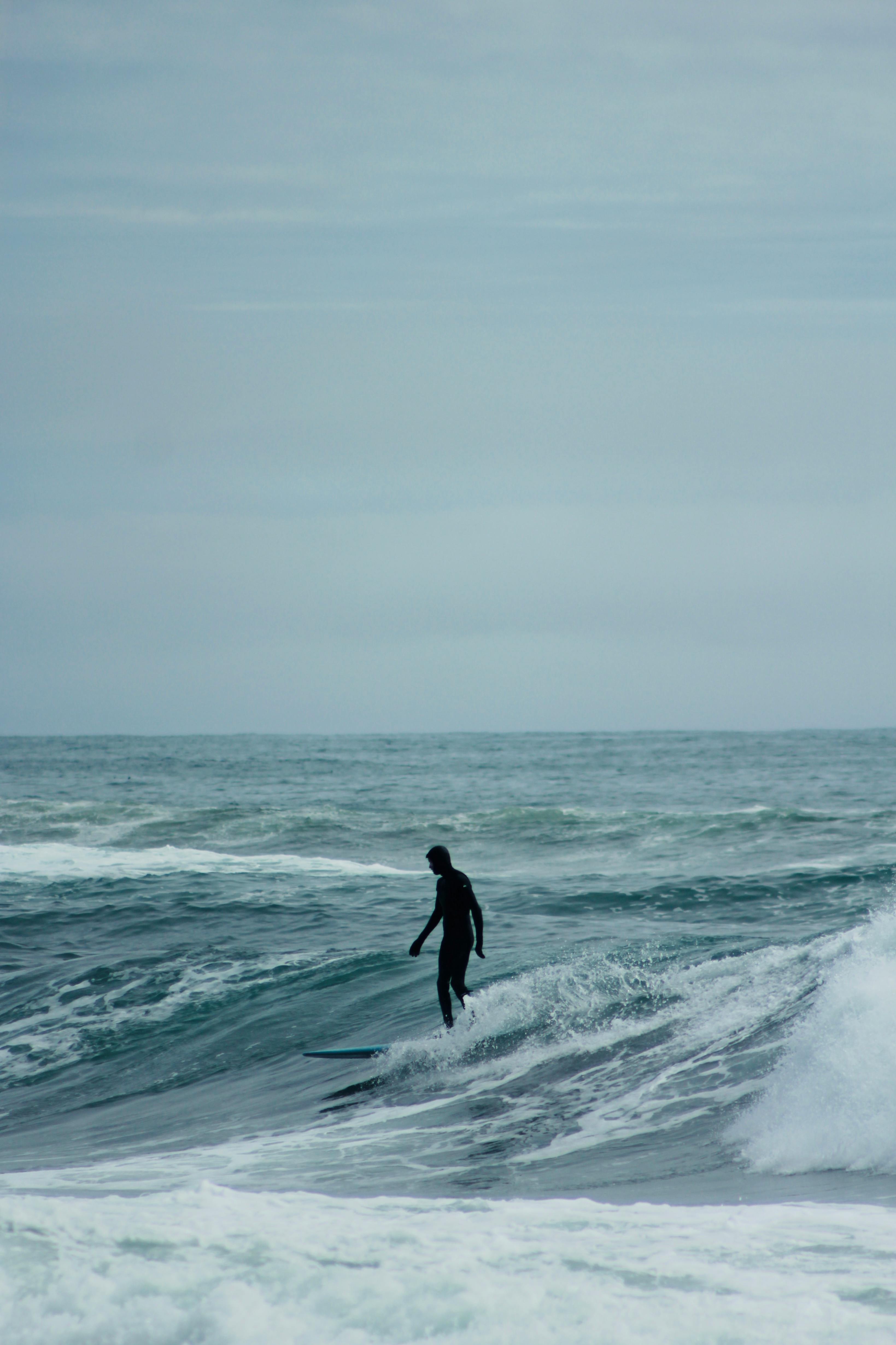Photo of a Man Surfing Sea Waves · Free Stock Photo
