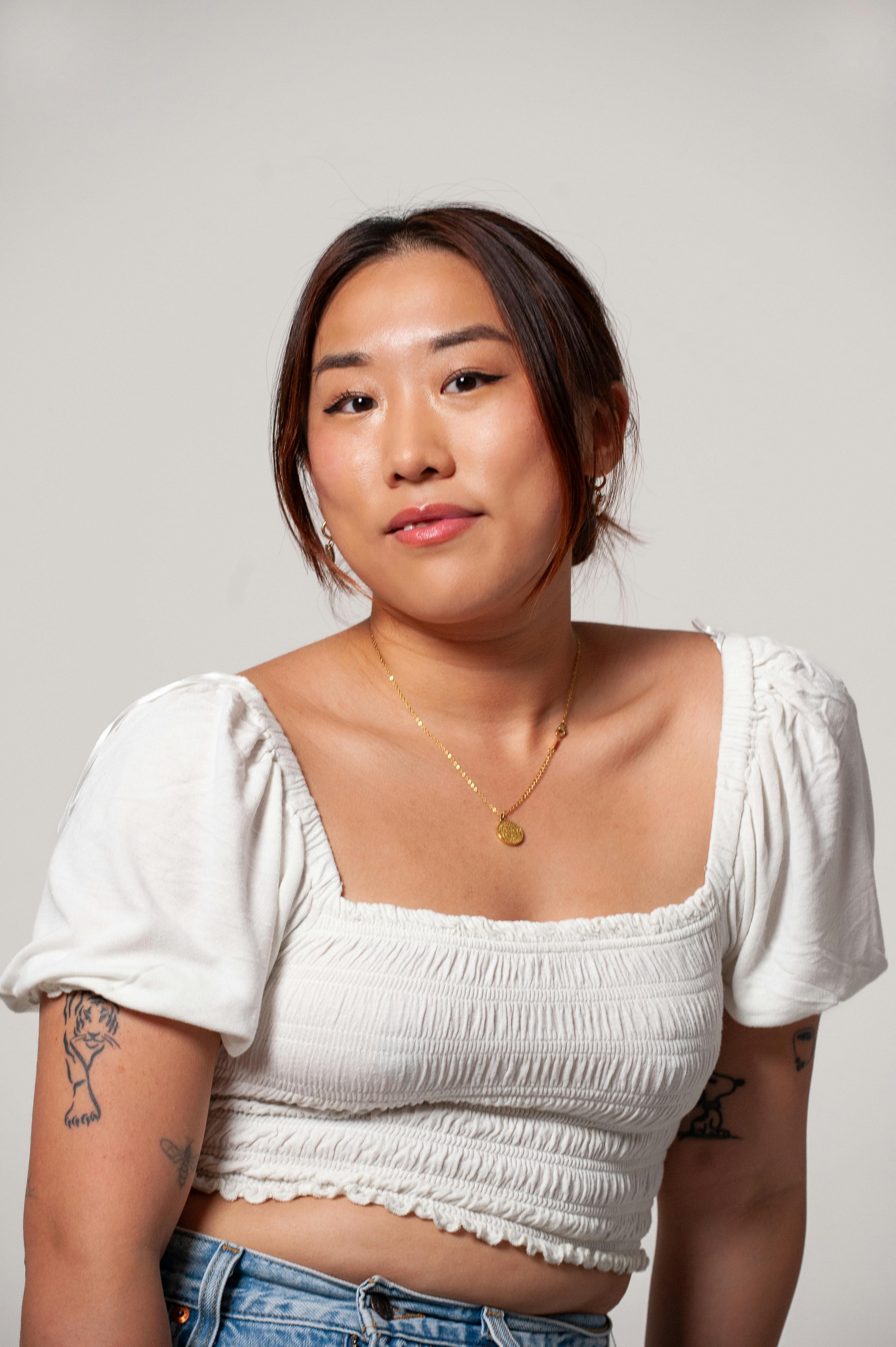 Photo of a Woman Posing with Her Hands Behind Her Back · Free Stock Photo