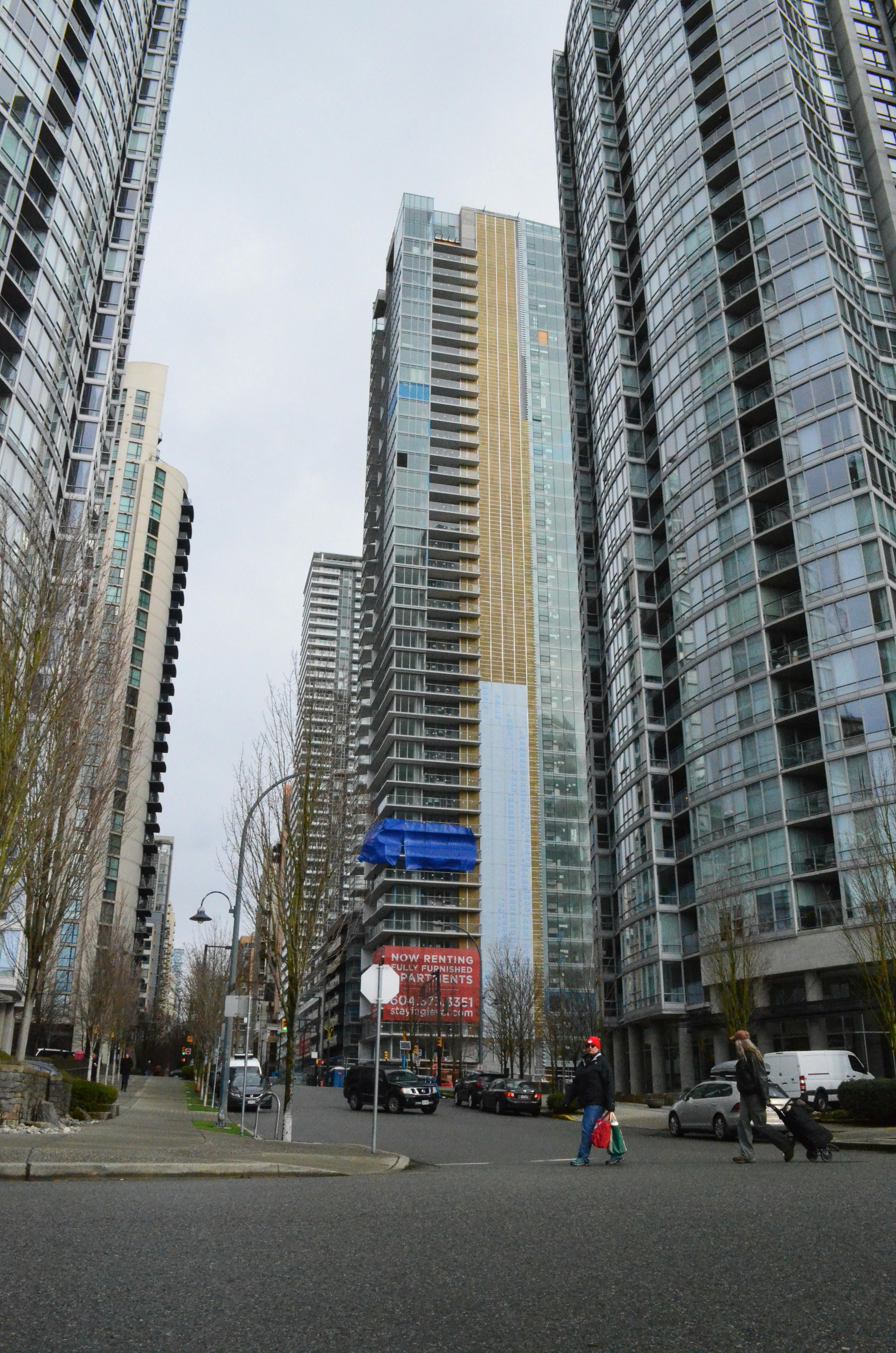Pedestrians Crossing the Street Between High Rise Buildings · Free ...