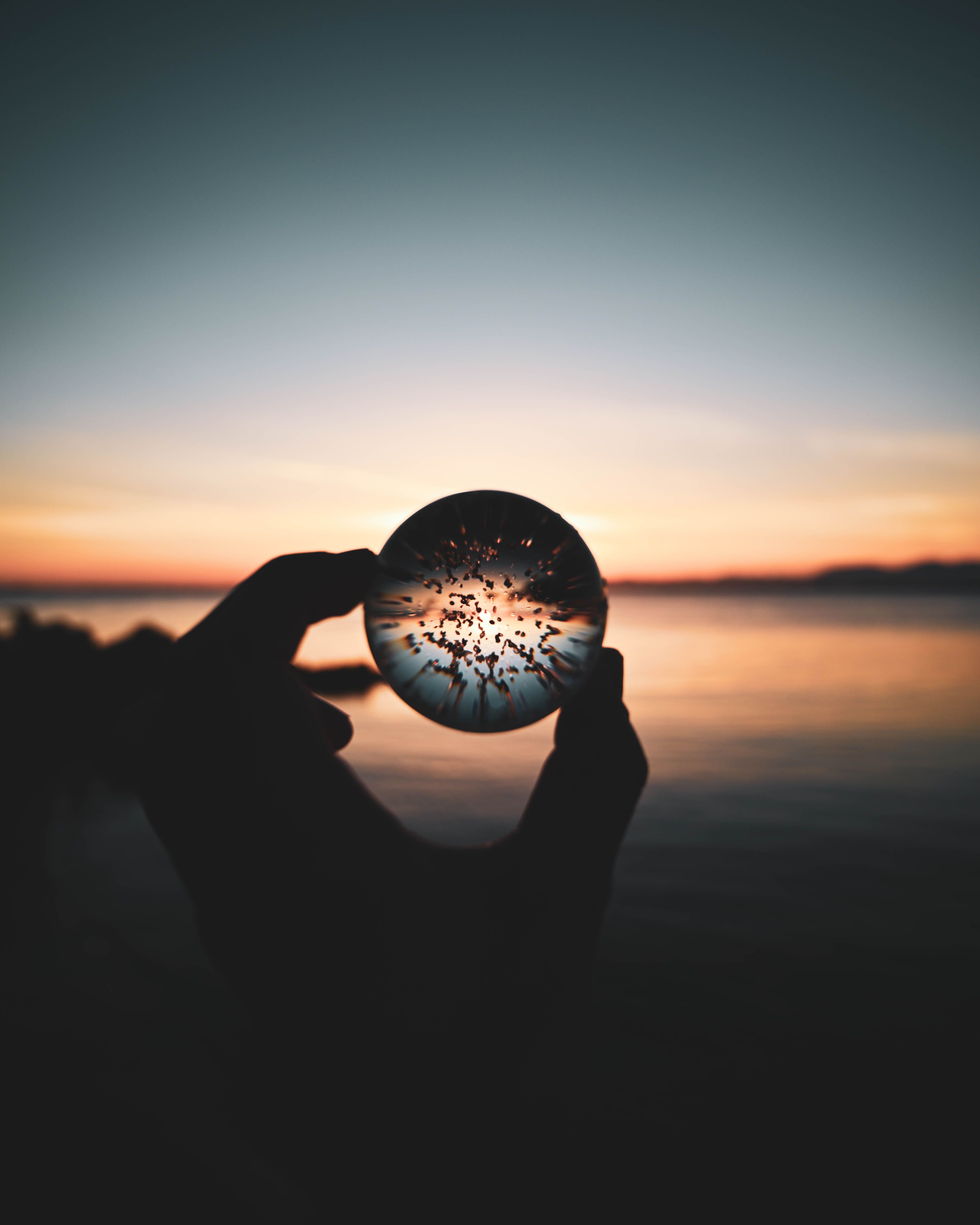 Person Holding Clear Glass Ball · Free Stock Photo