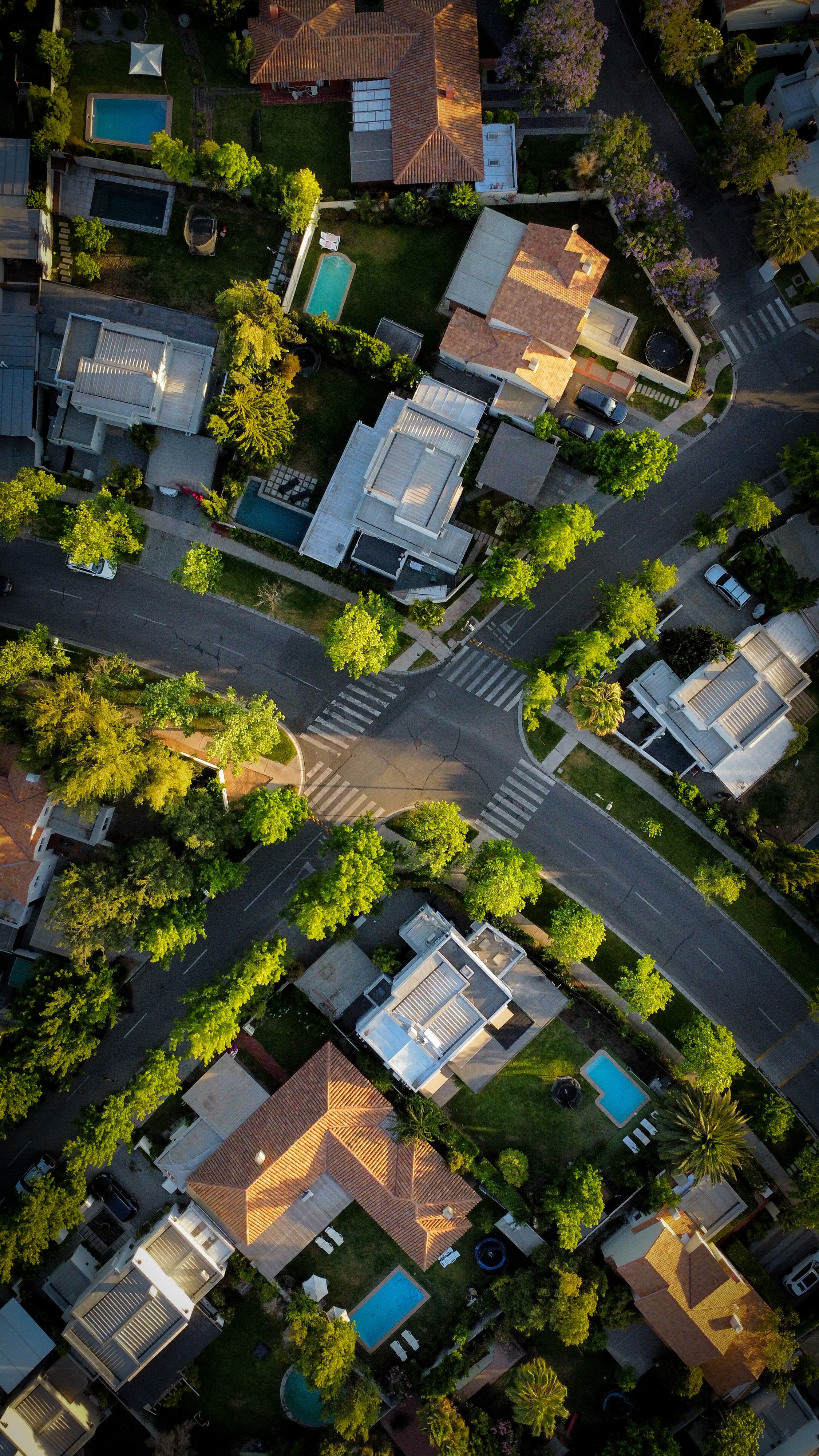 Aerial View of a Road with Intersection Between Houses · Free Stock Photo