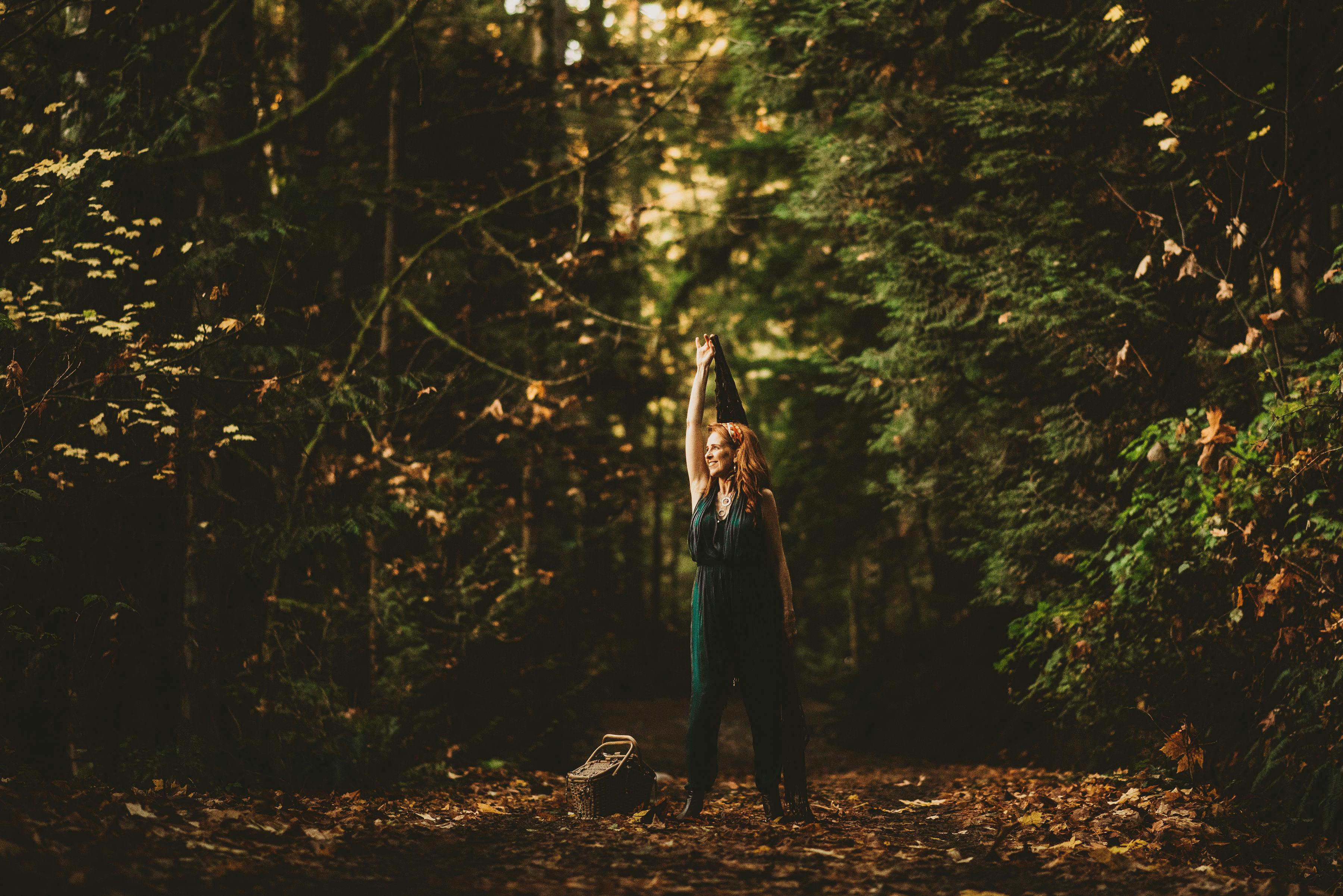 A Woman Standing in Between Green Trees · Free Stock Photo