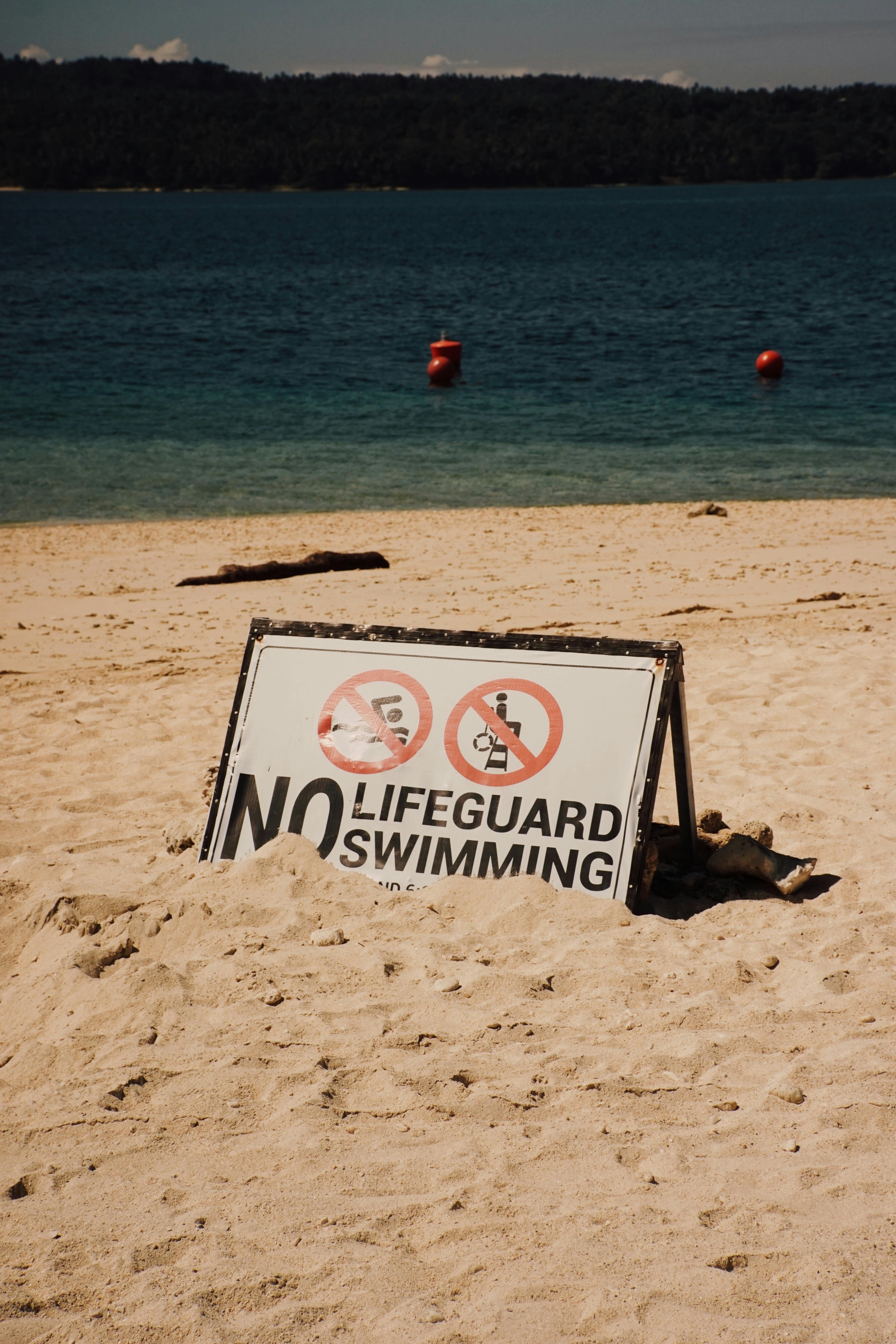 No Swimming Signage on Seashore · Free Stock Photo