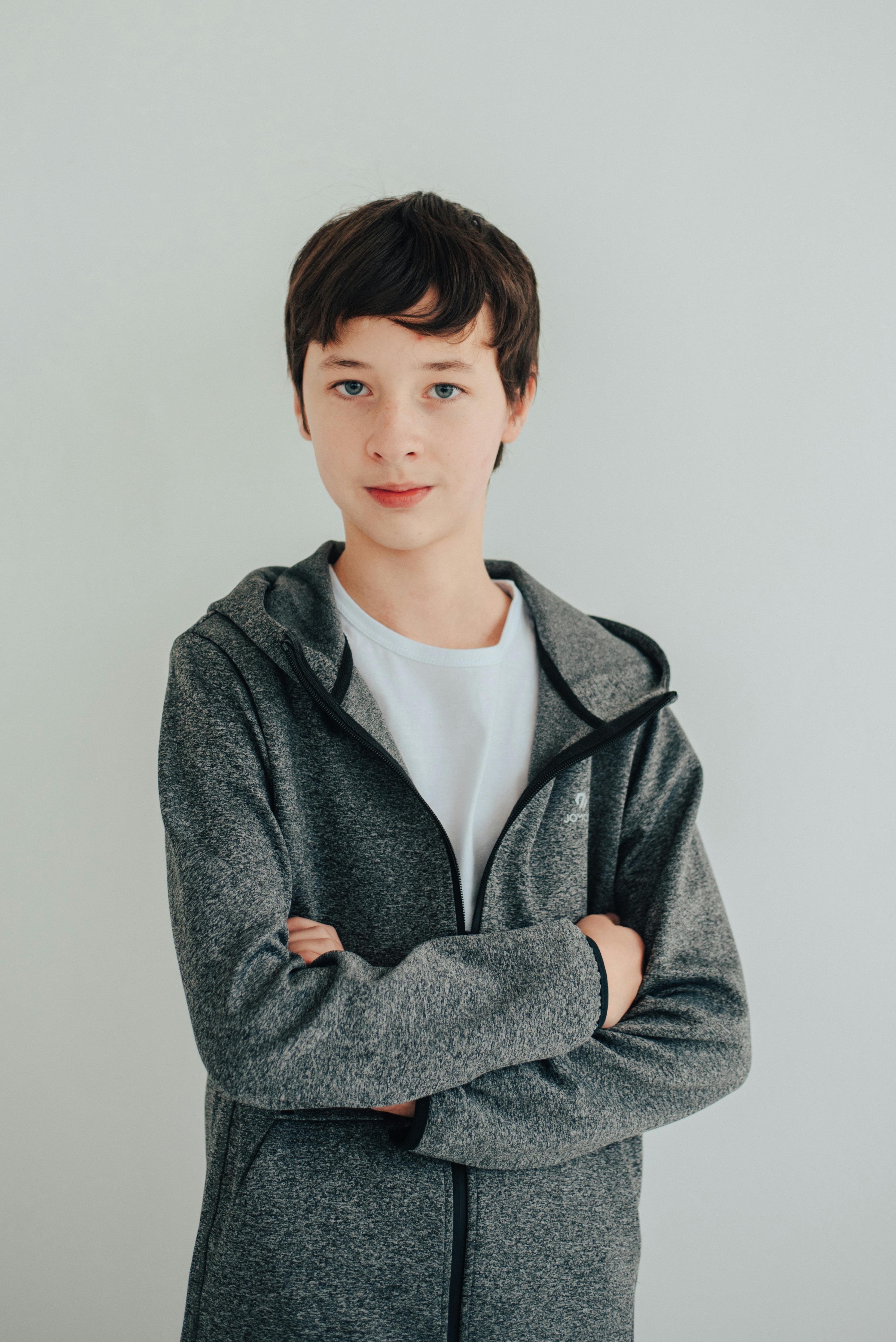 Portrait of a Boy Wearing Gray Jacket on White Background · Free Stock ...