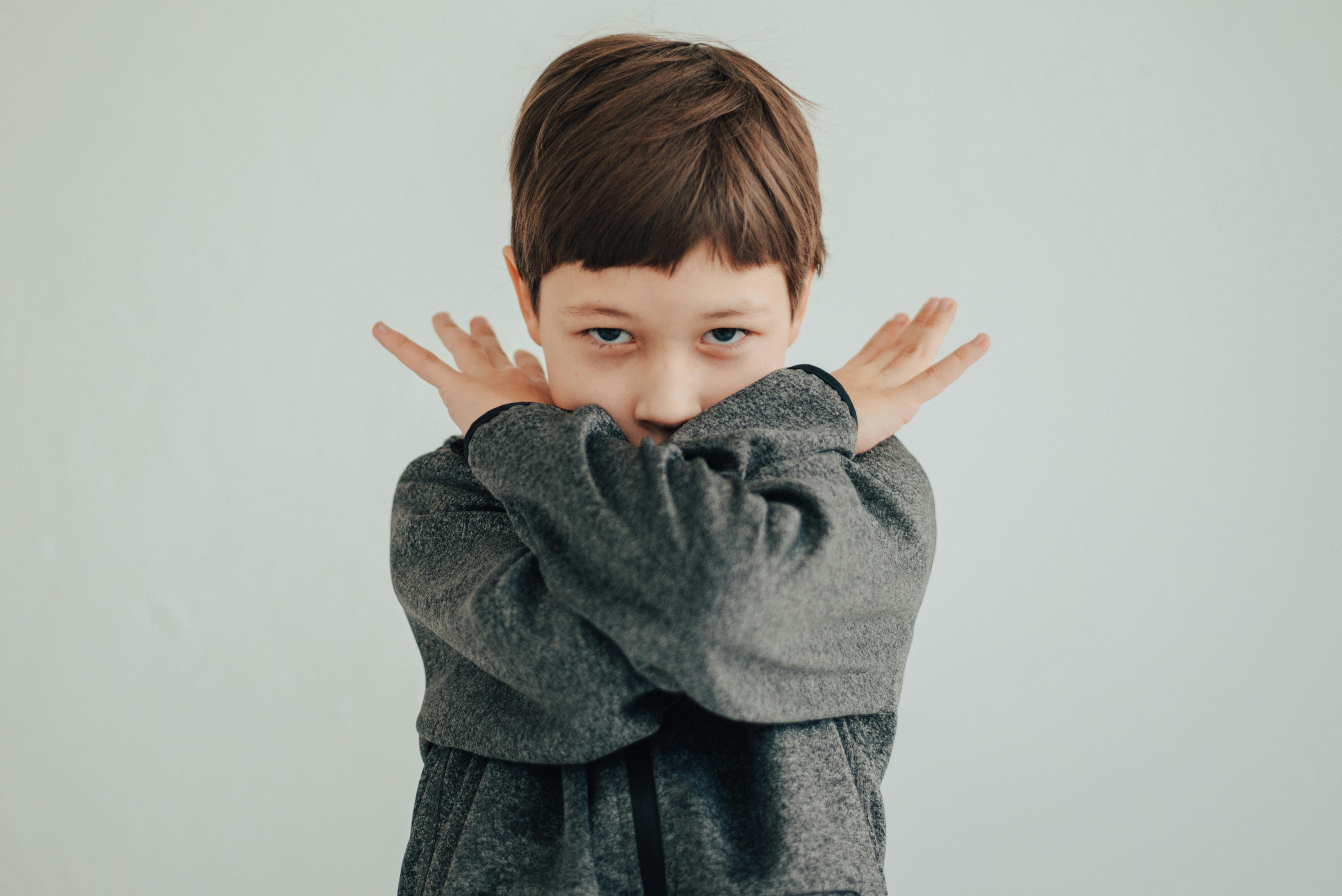 Angry Boy in Hood on Black Background · Free Stock Photo