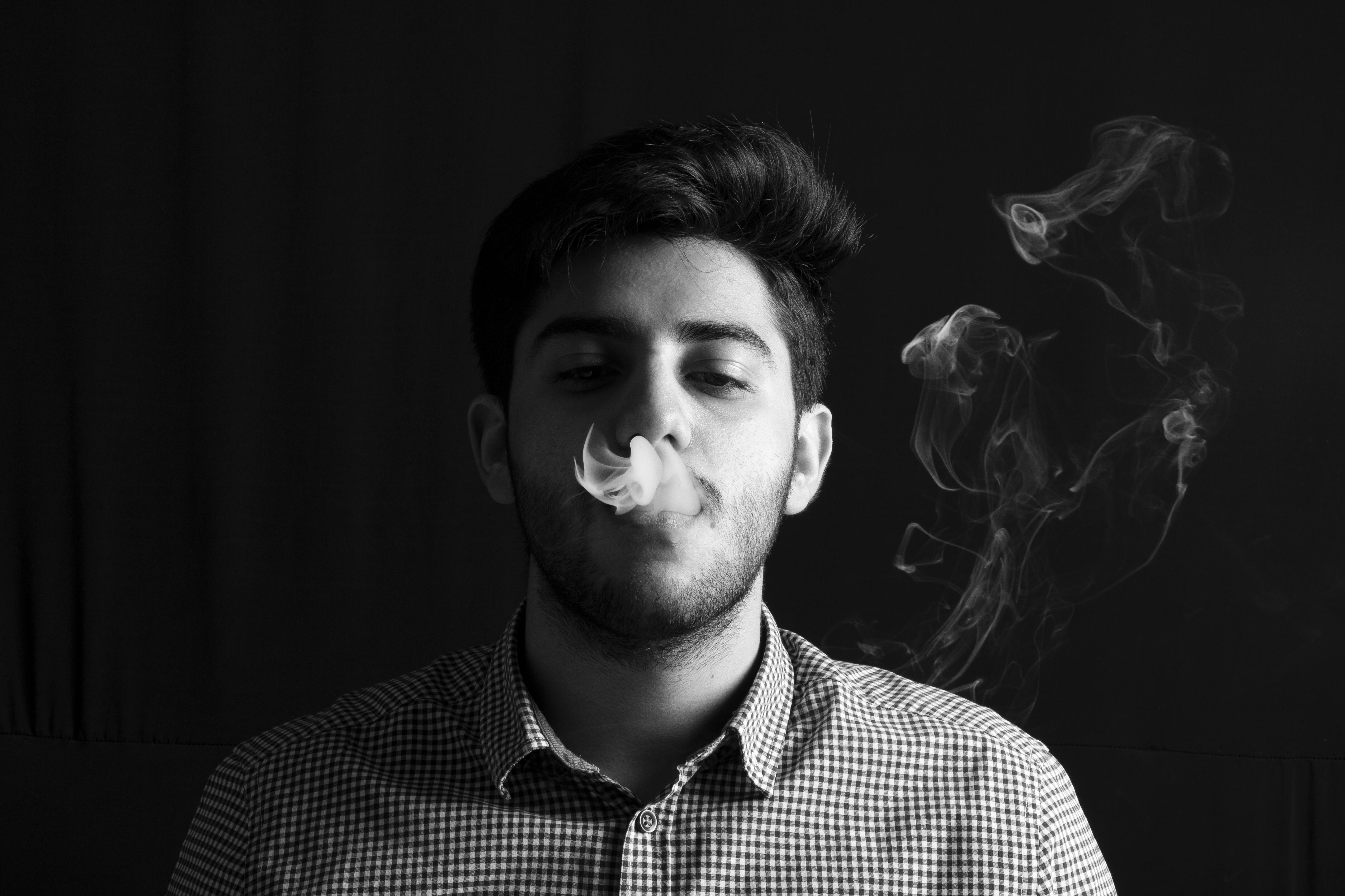 Close-up of Person Emitting Smoke · Free Stock Photo