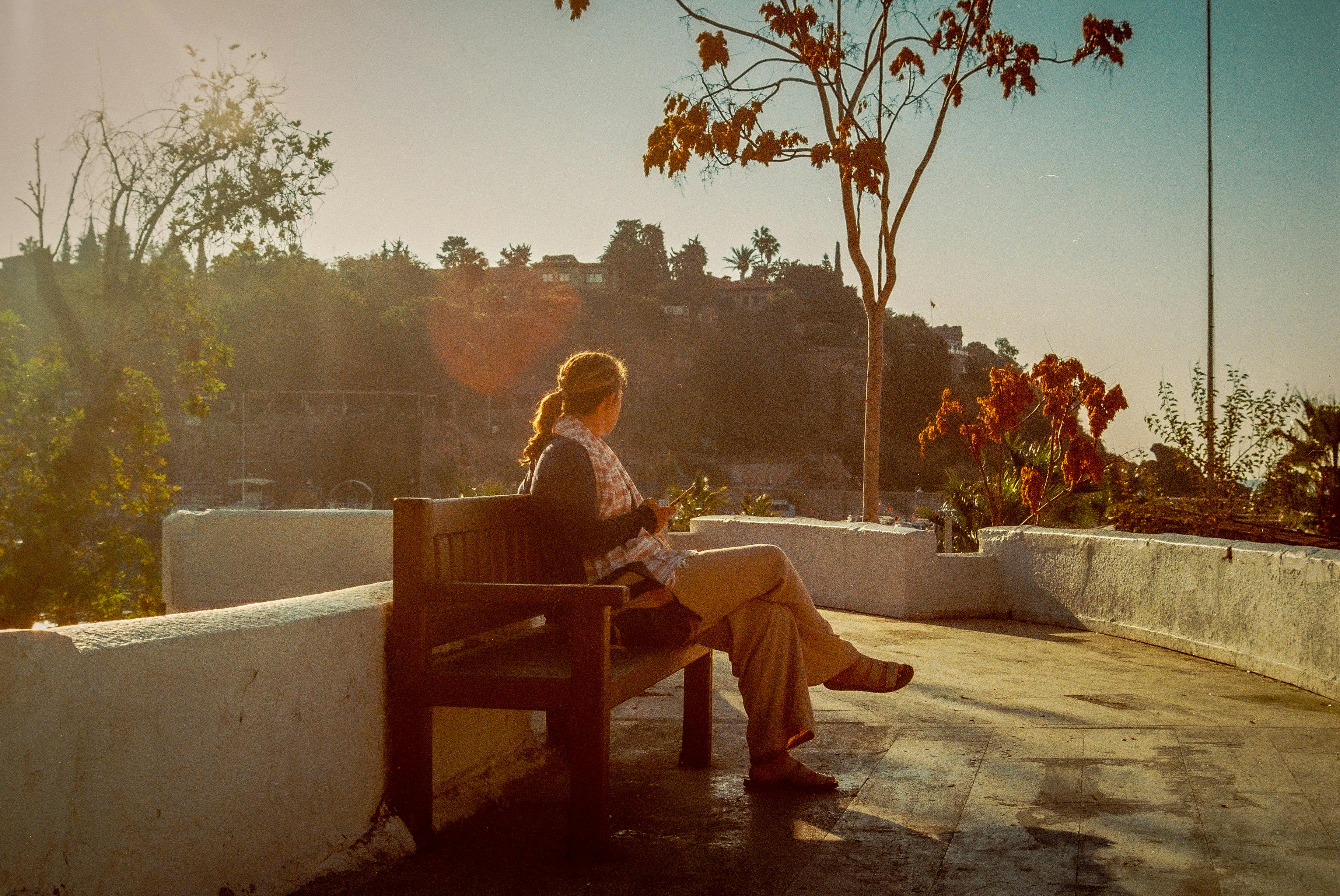 Photo of Person sitting on Wooden Bench · Free Stock Photo