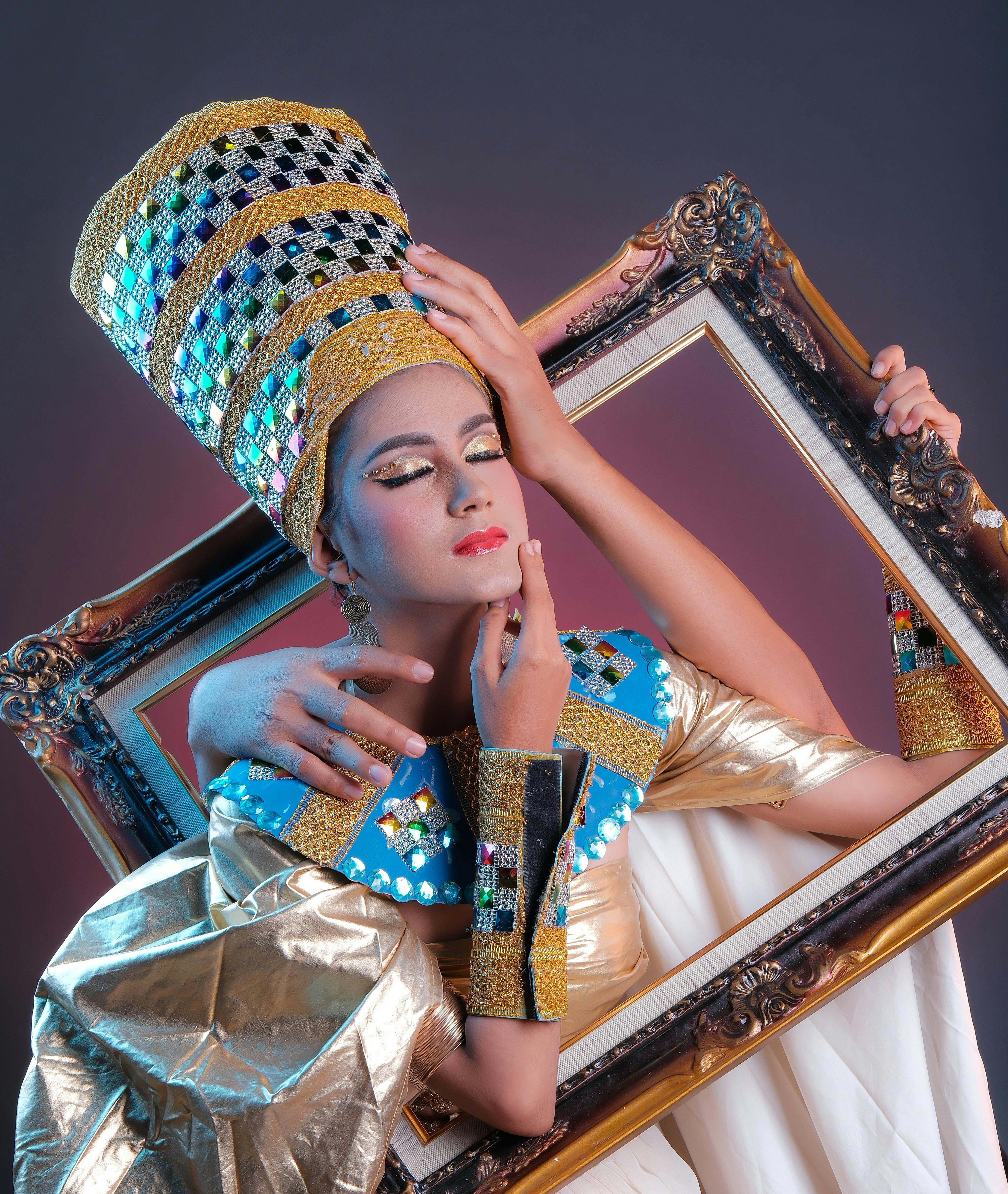 Woman in a Costume Posing with a Picture Frame · Free Stock Photo