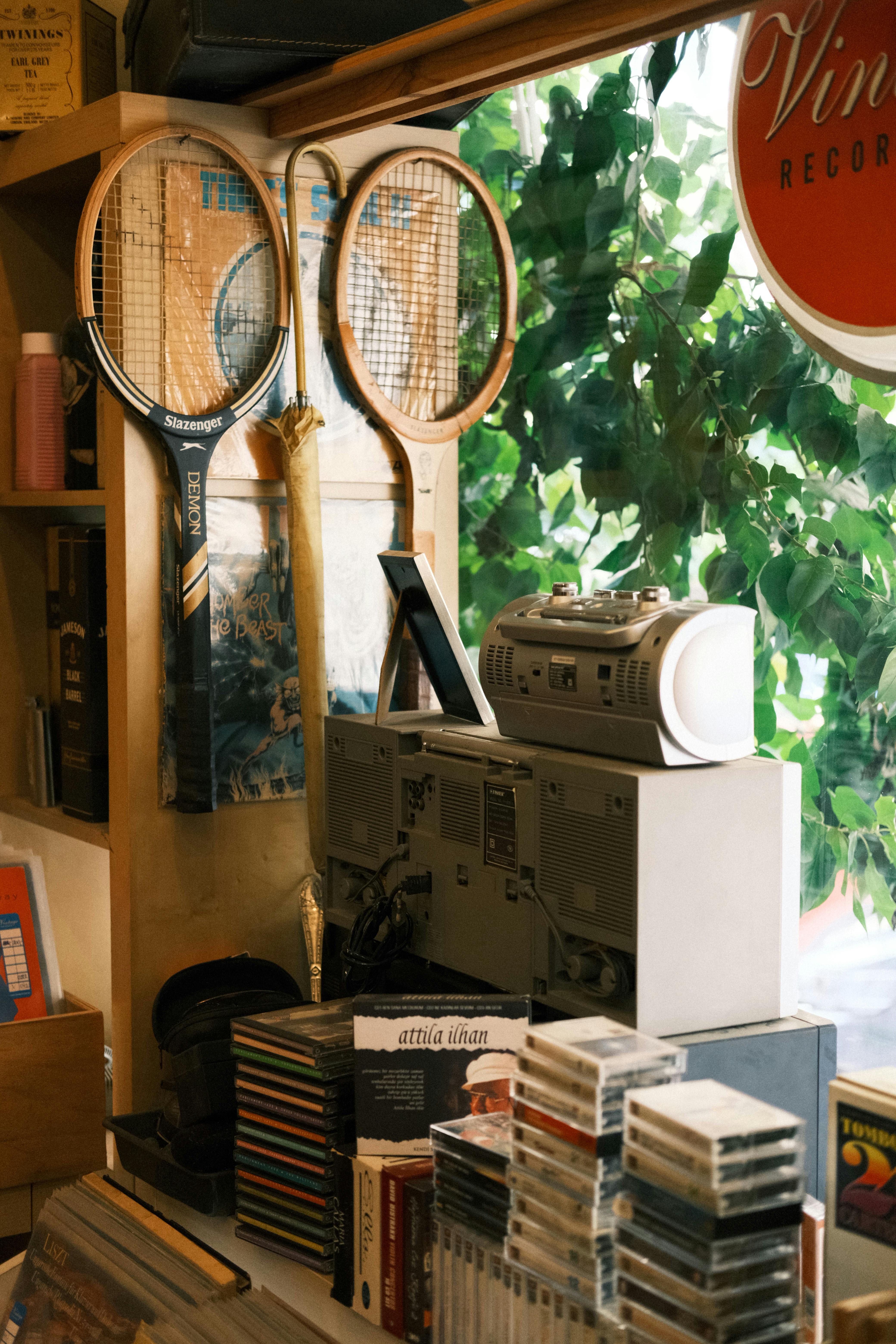 Tennis Rackets Hanging on Brown Wooden Shelves · Free Stock Photo