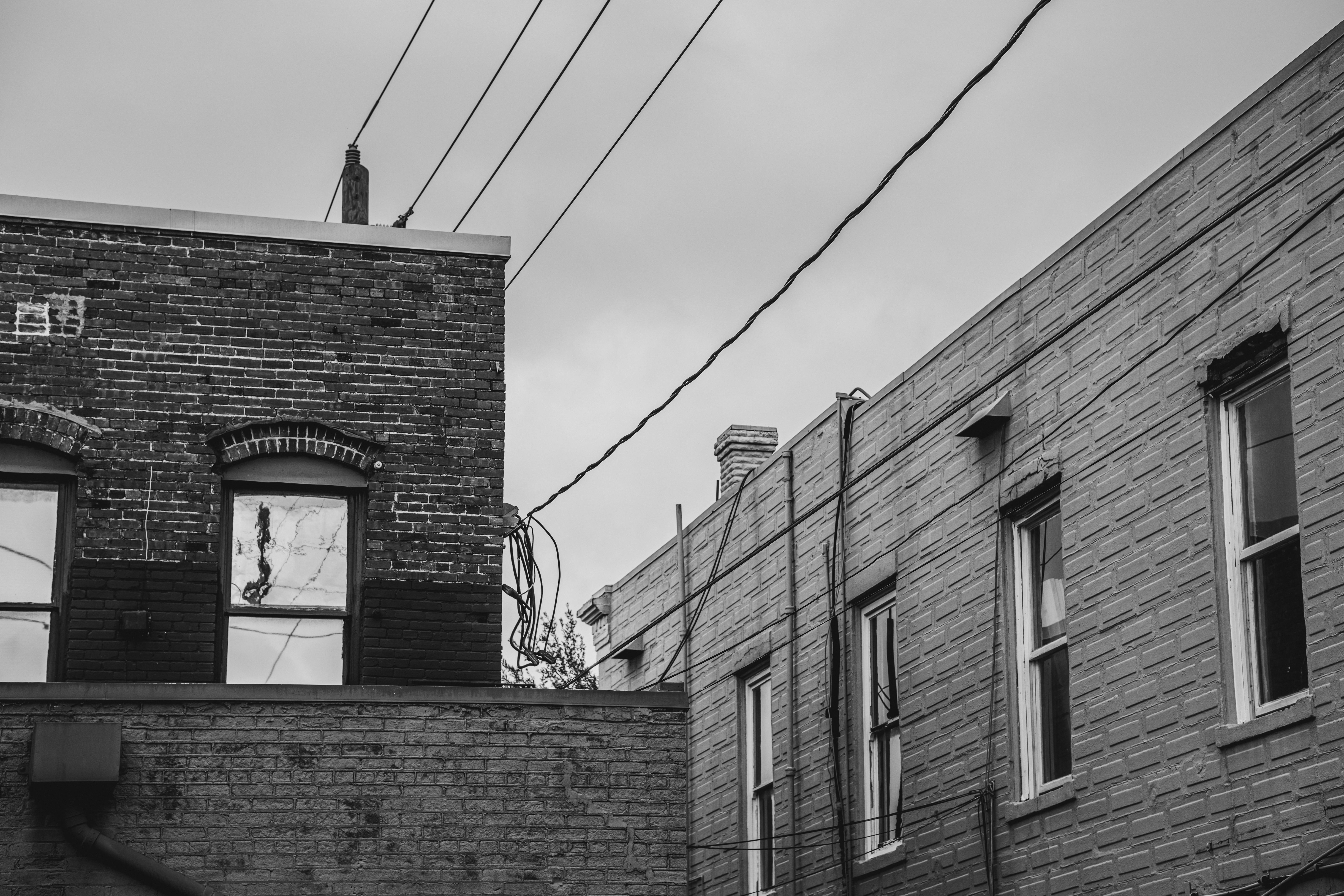 Grayscale Photo of Brick Buildings · Free Stock Photo