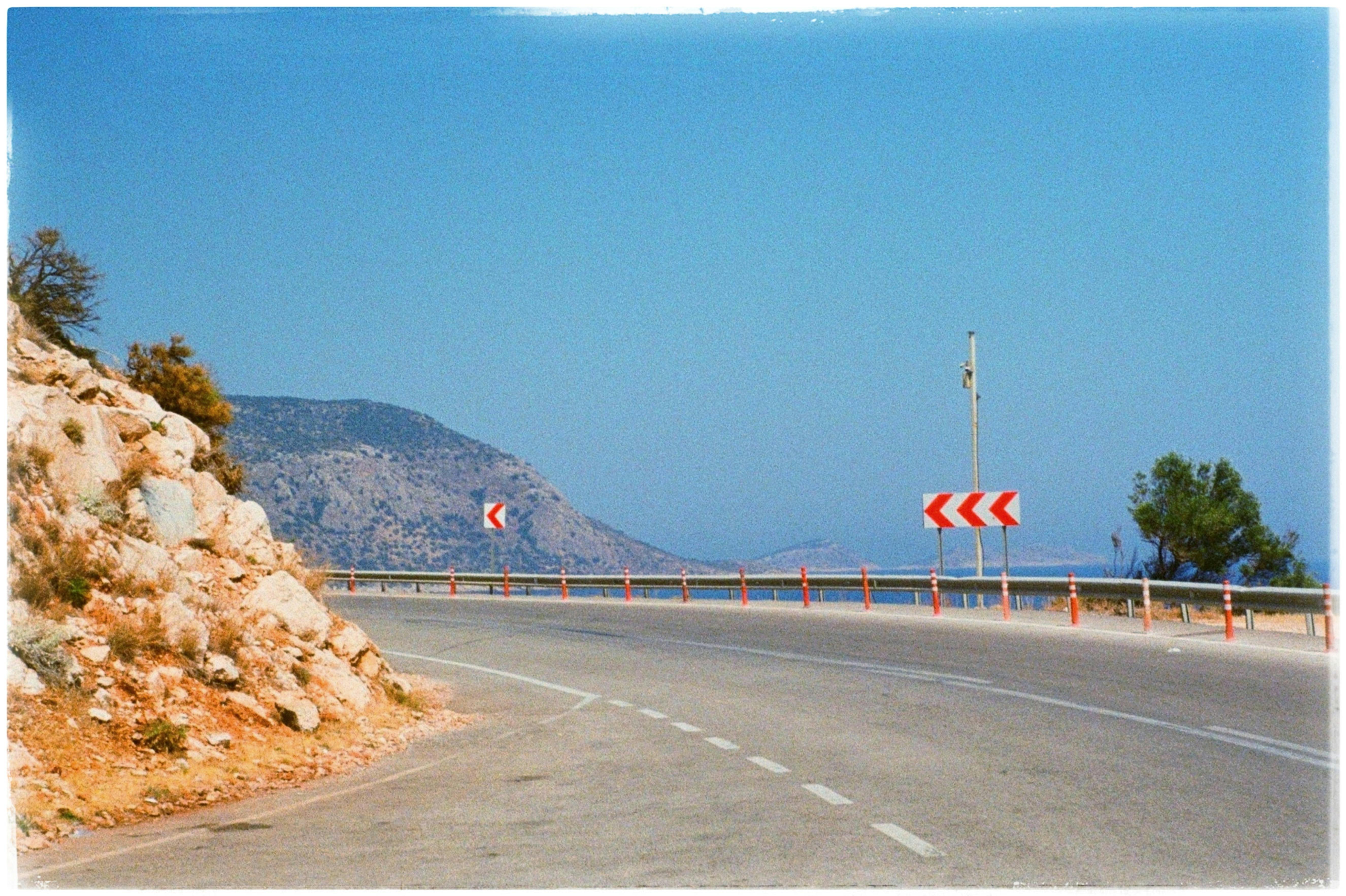 Signs on Road in Mountains Landscape · Free Stock Photo