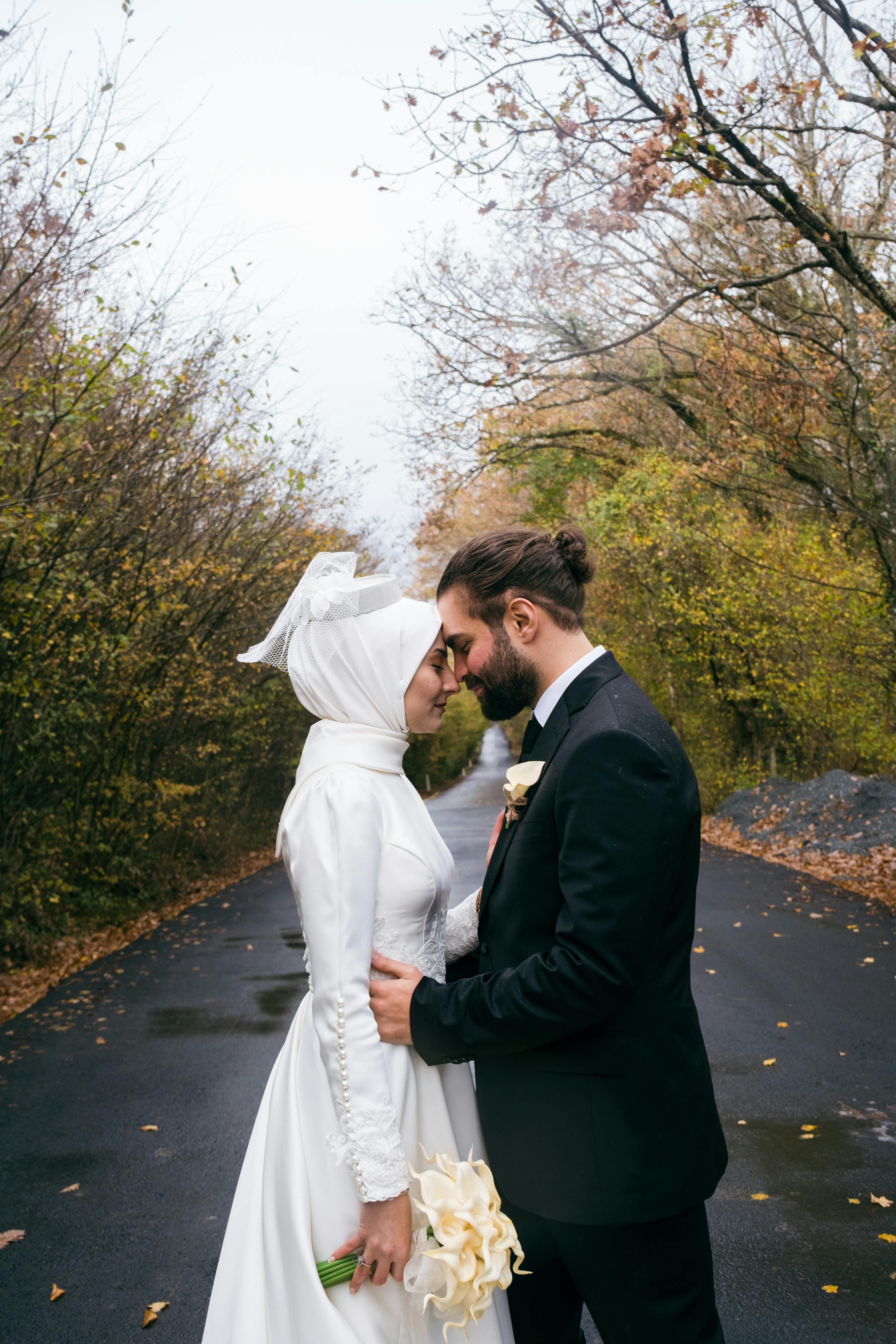 A Groom Holding His Bride Romantically · Free Stock Photo