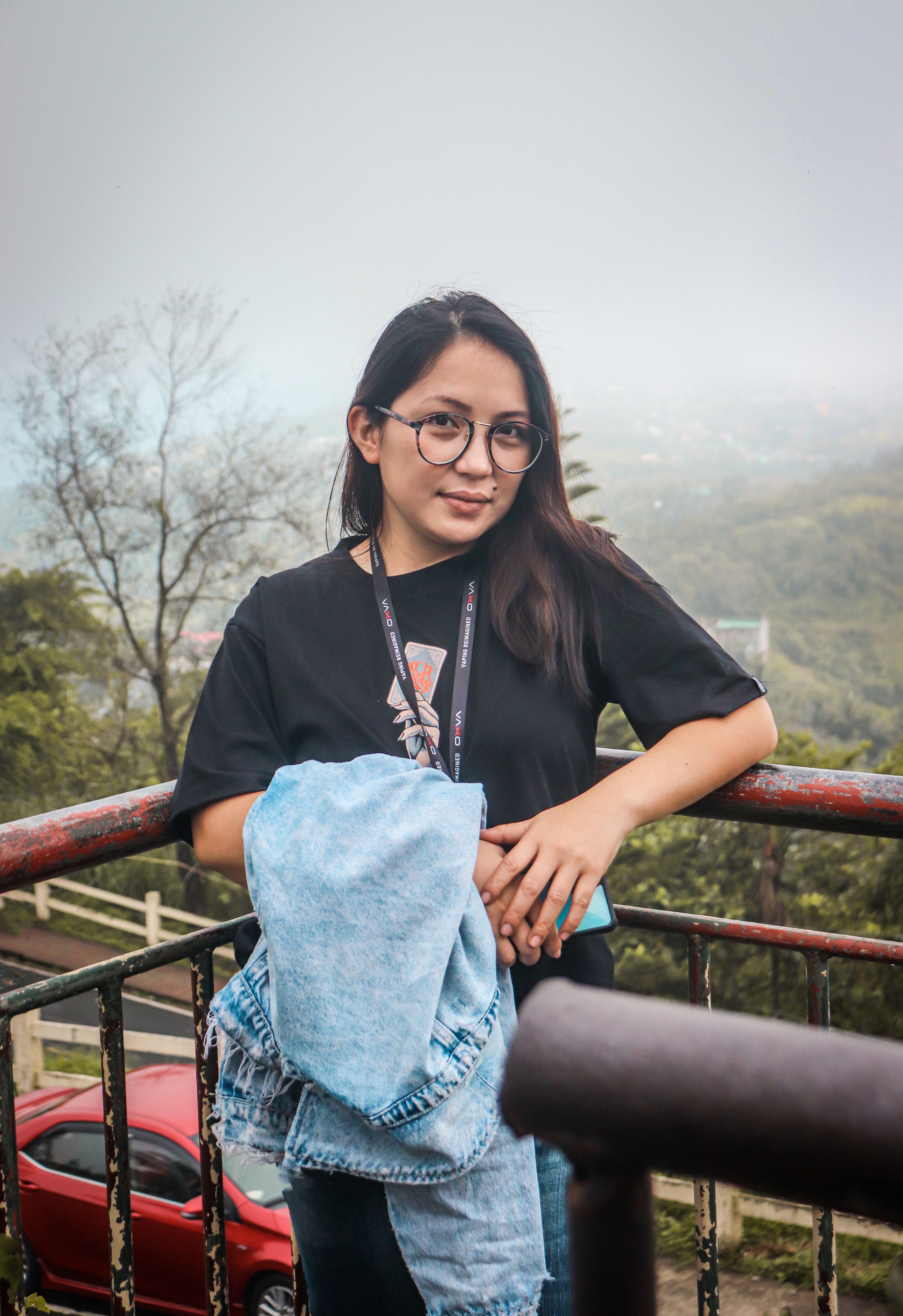 A Woman Wearing a Black Top and Eyeglasses Leaning on a Ledge · Free ...