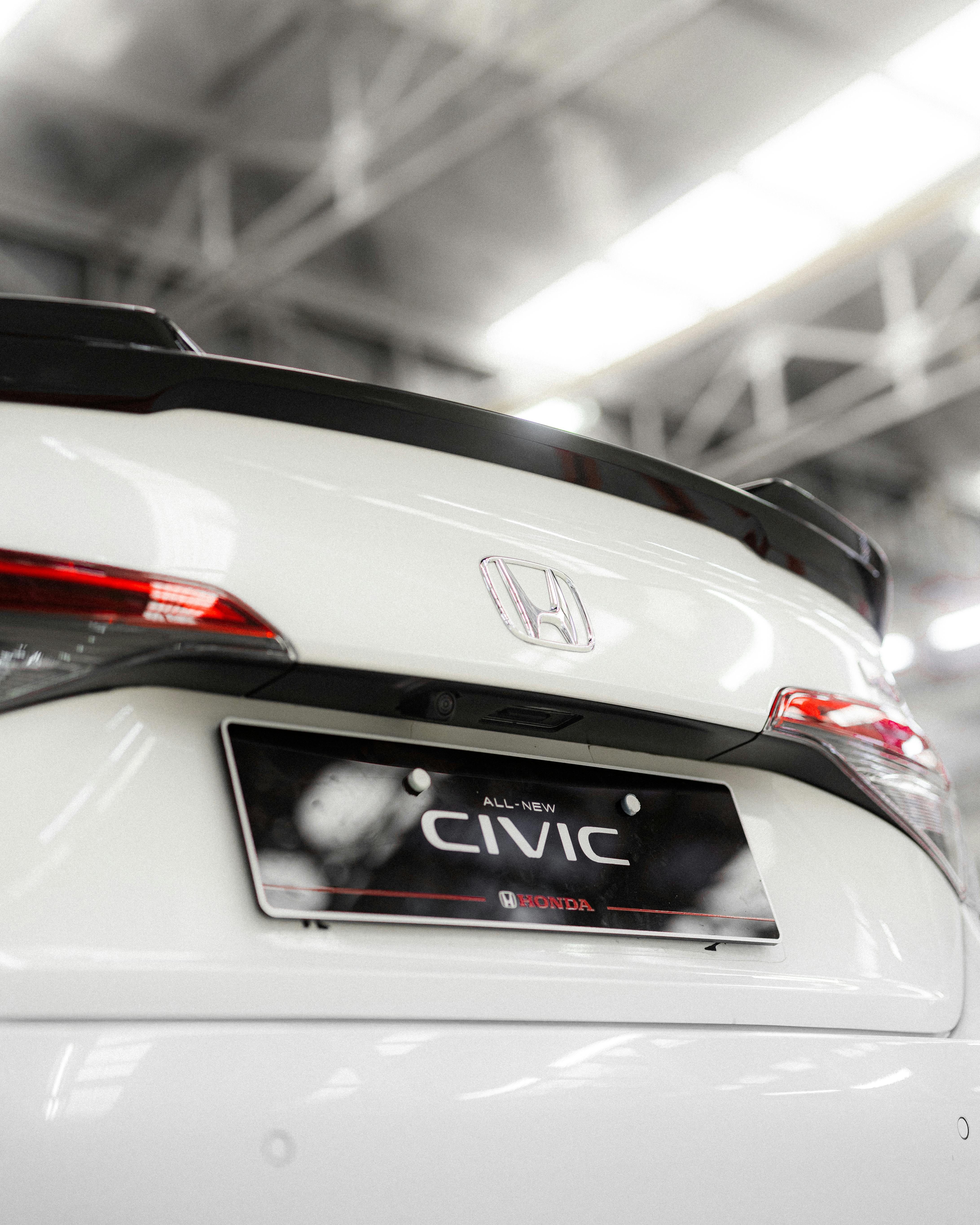 Car Sign on New Modern Automobile in Salon · Free Stock Photo