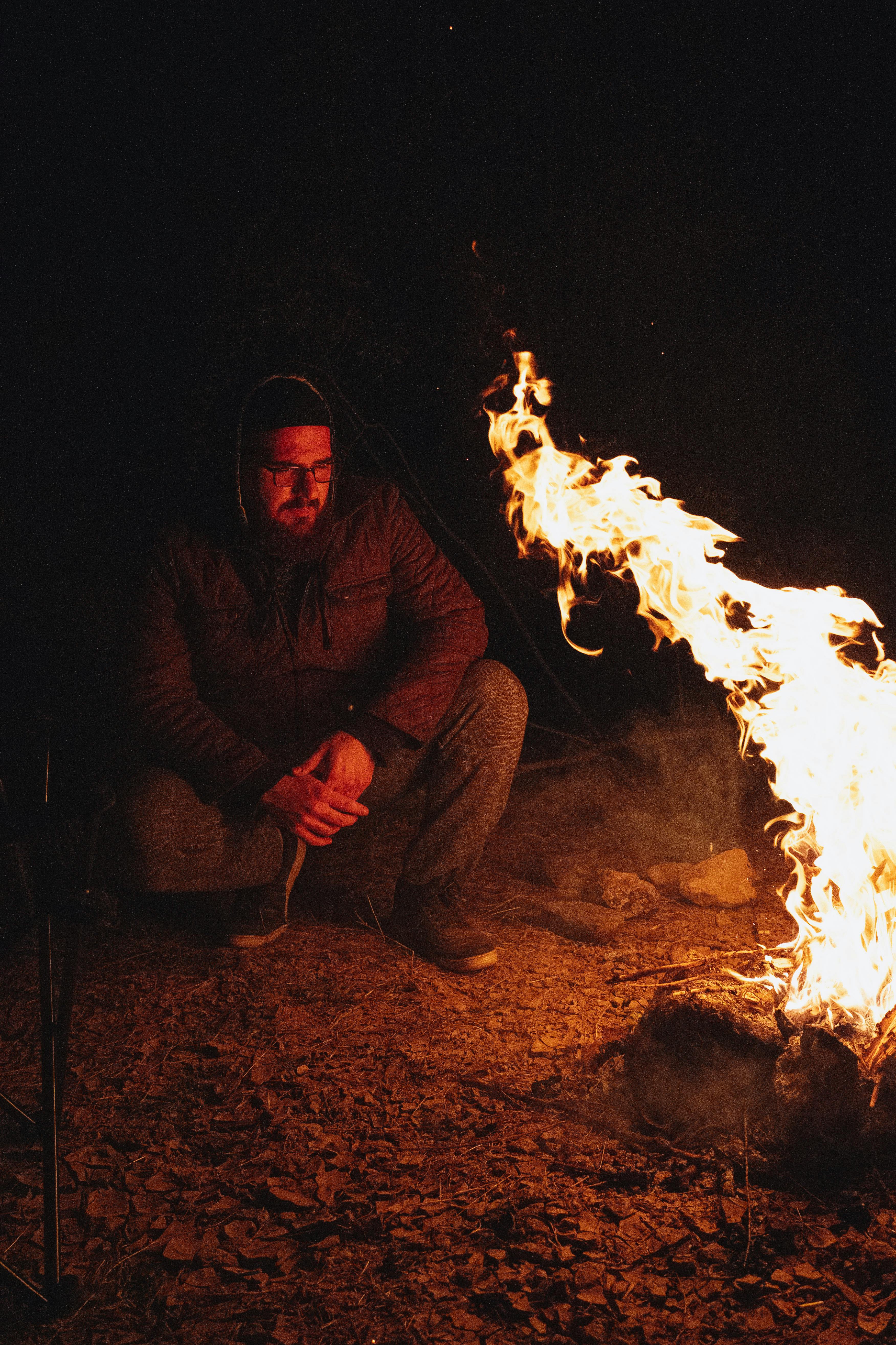 Man Sitting by the Campfire · Free Stock Photo