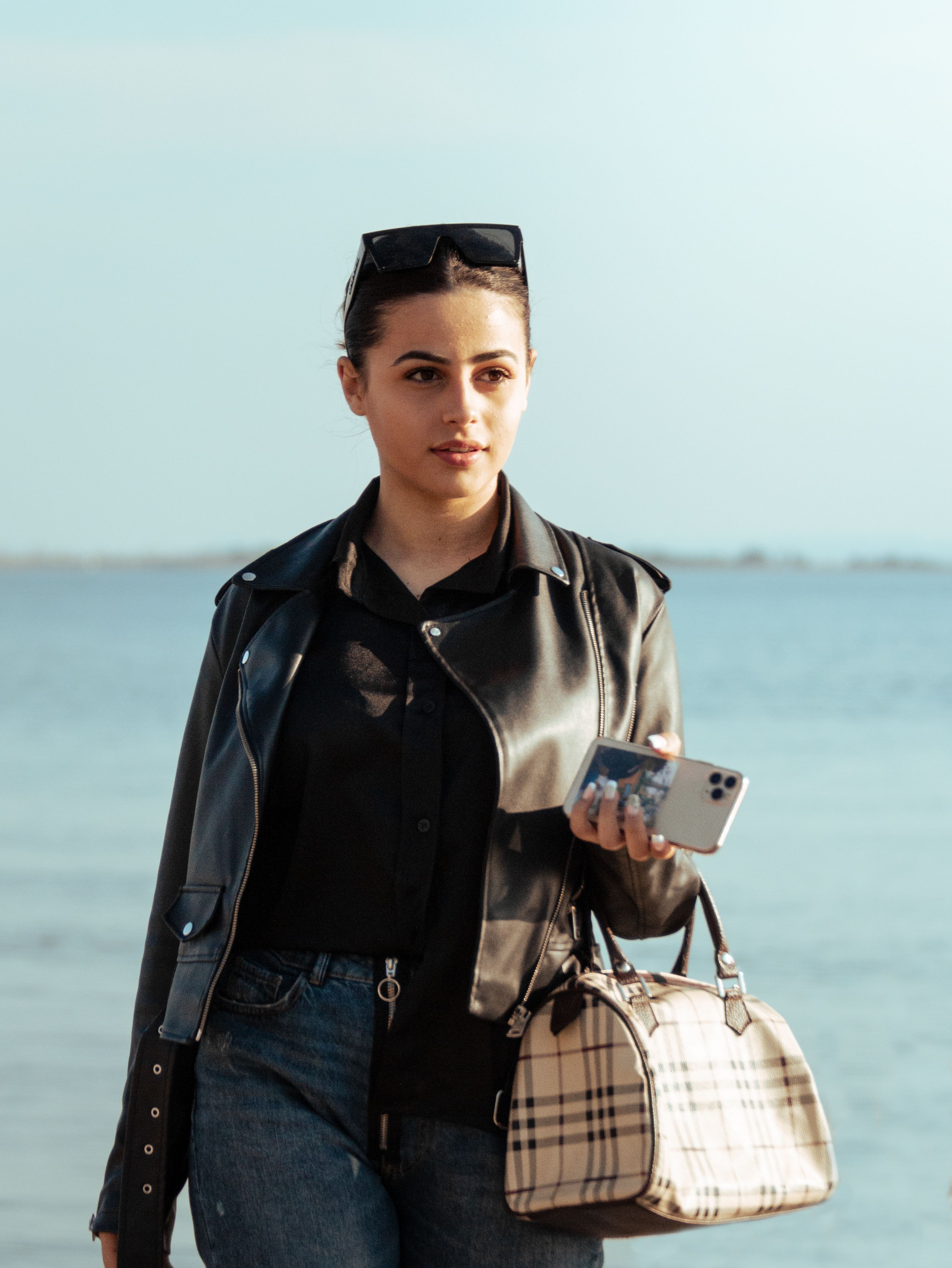 Woman in Leather Jacket Holding Smartphone · Free Stock Photo
