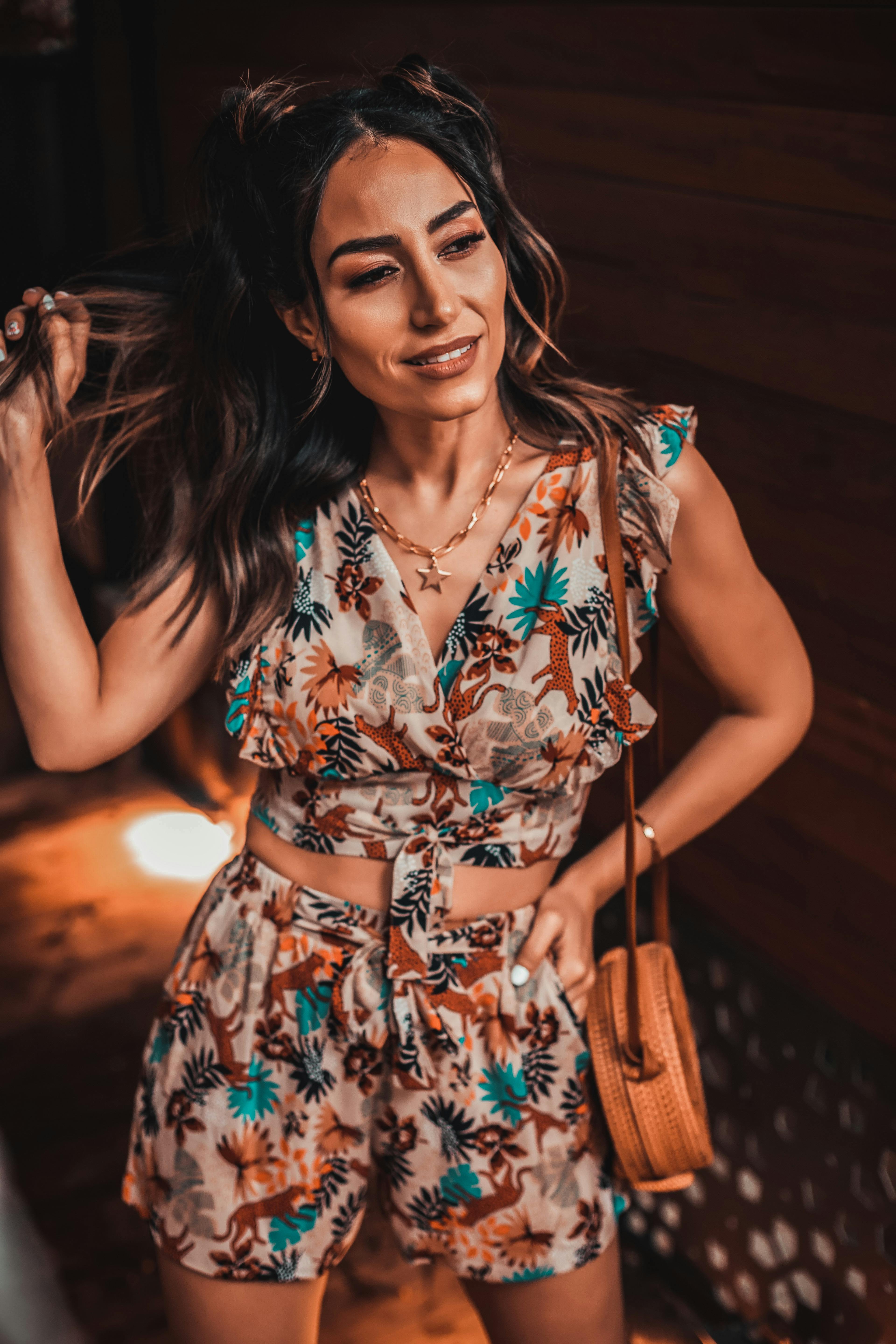 A Woman in Terno Clothes Smiling while Holding Her Hair · Free Stock Photo