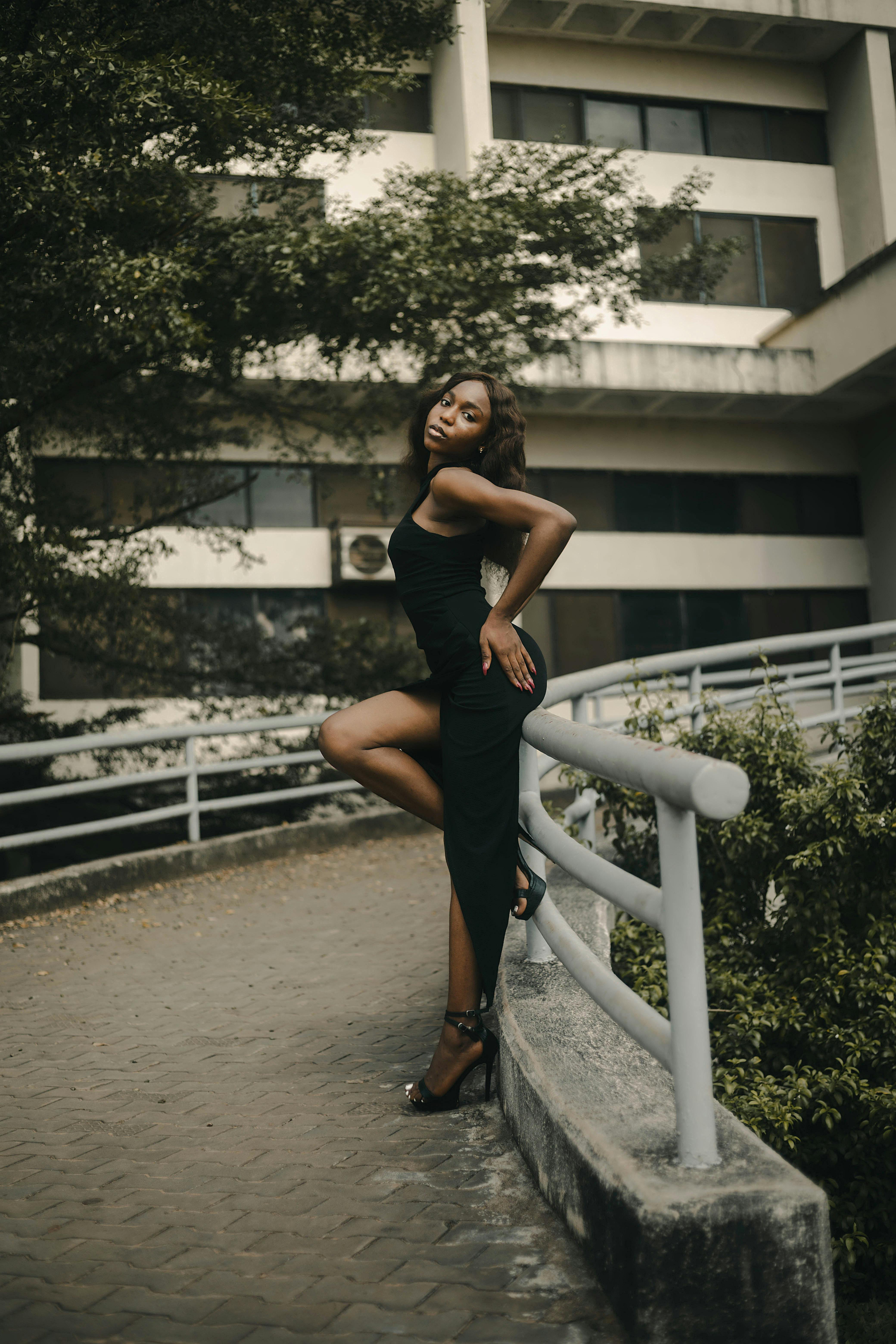 Woman in Dress Posing by Railing · Free Stock Photo