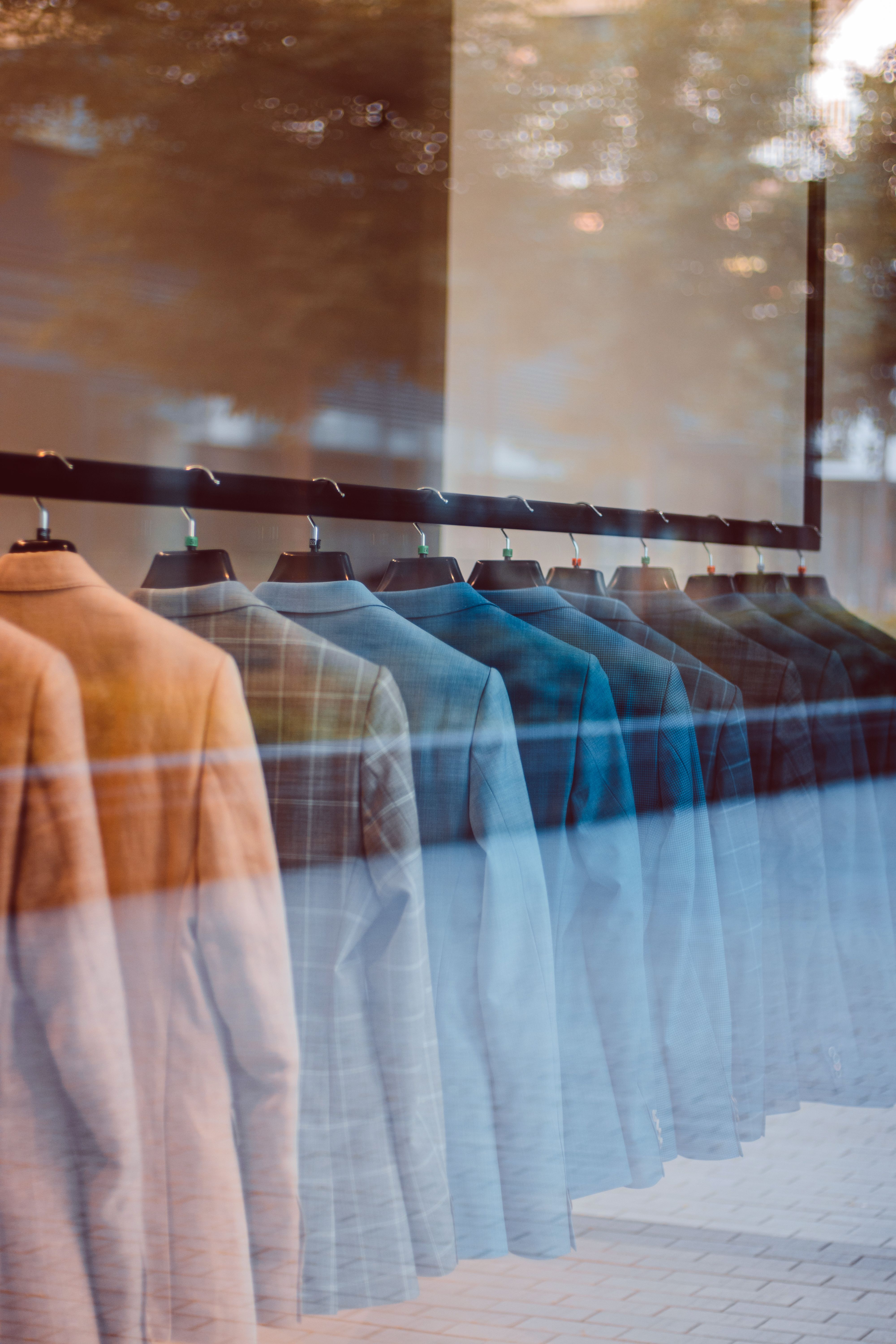 Window Display of Jackets Sorted by Colour · Free Stock Photo