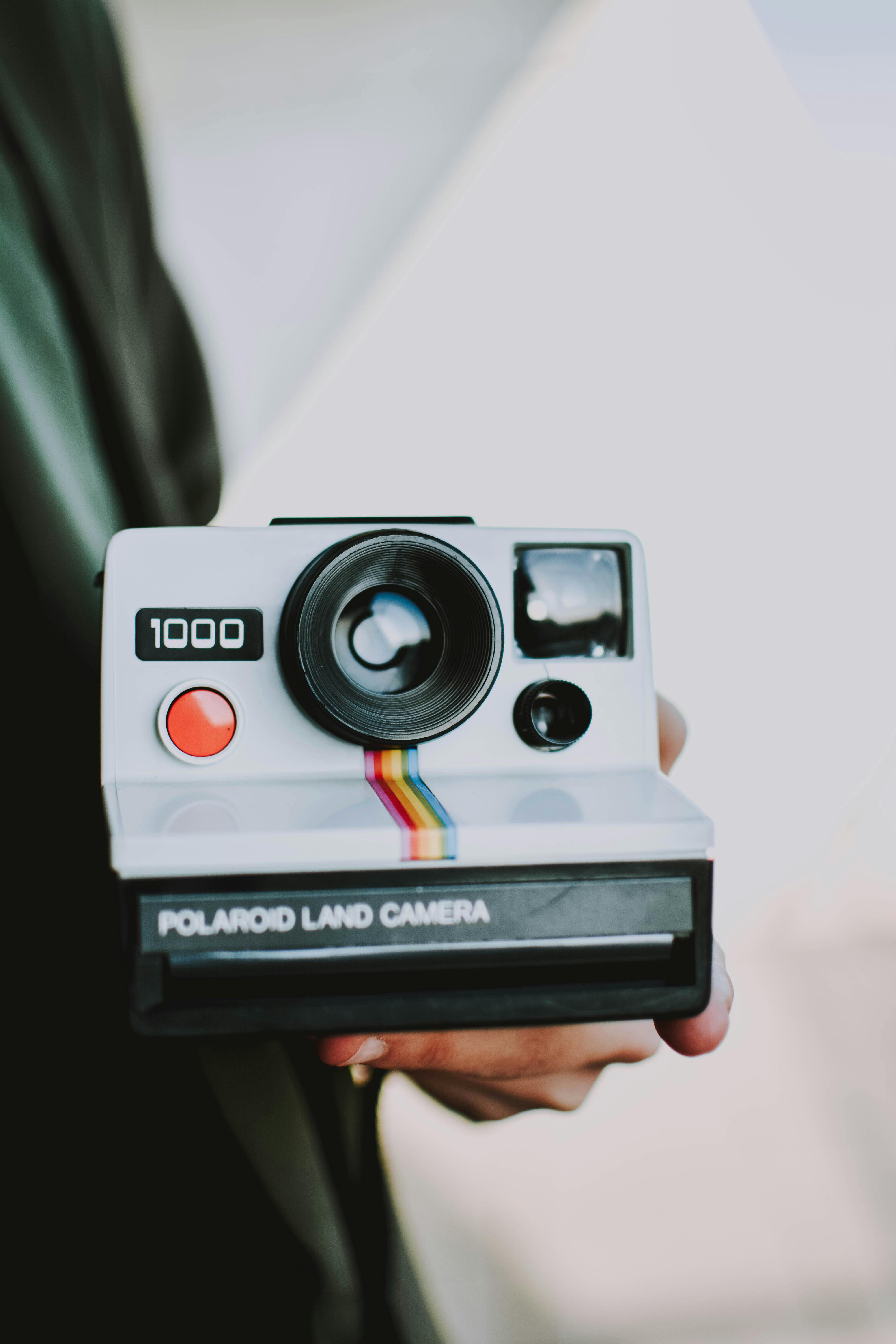 Person Holding Gray Polaroid Land Camera · Free Stock Photo