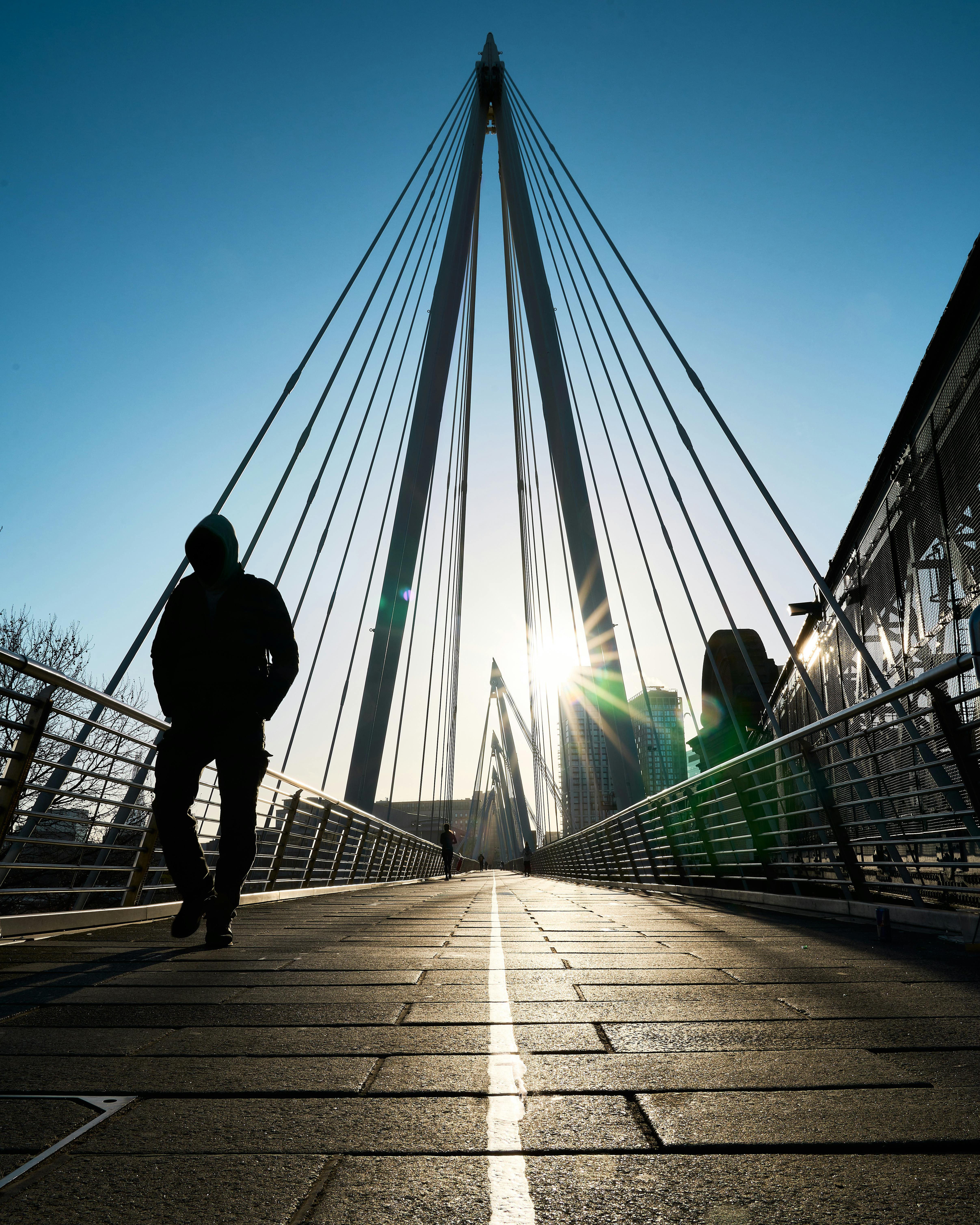 A Man Walking on the Bridge · Free Stock Photo