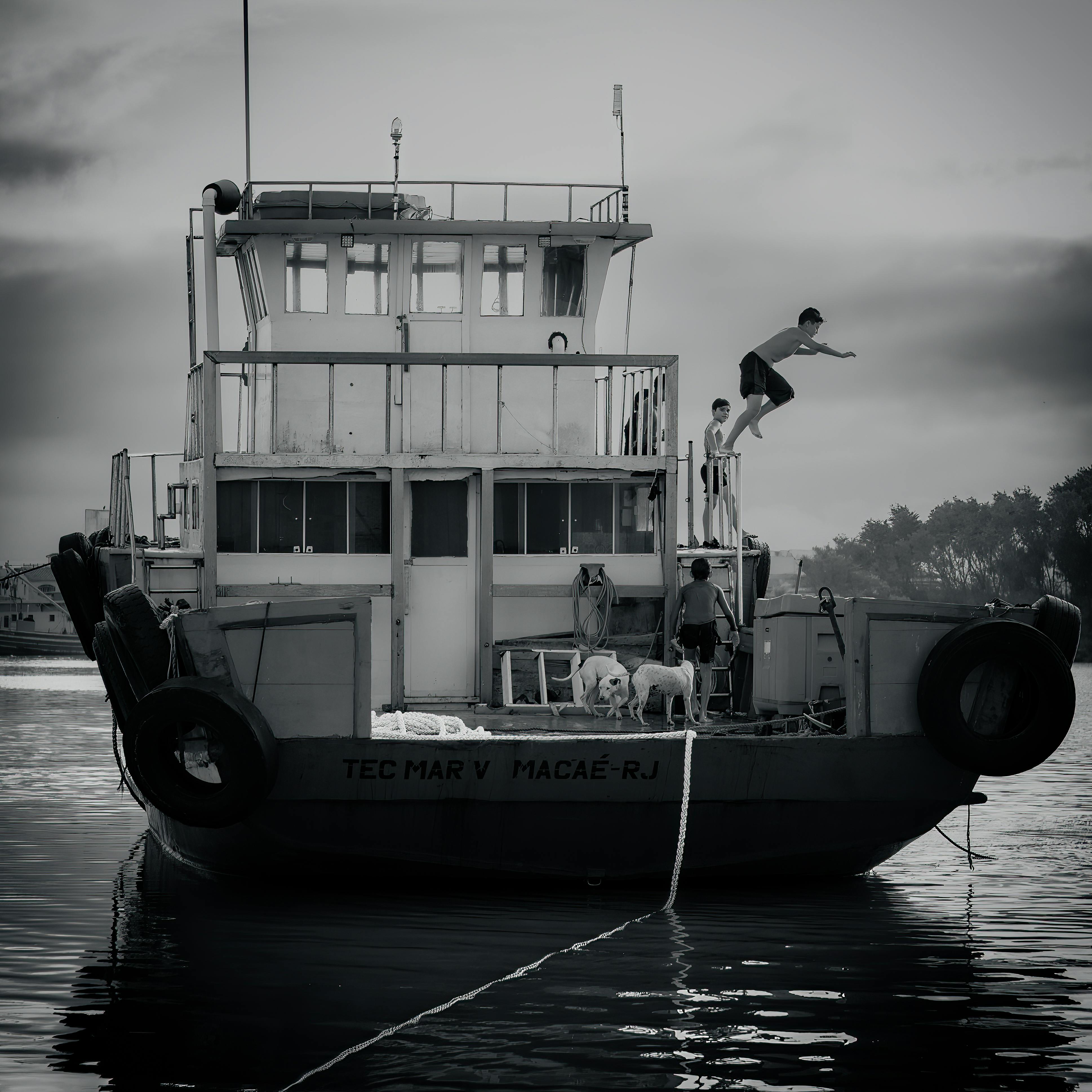 A Boy Jumping Off a Ship · Free Stock Photo