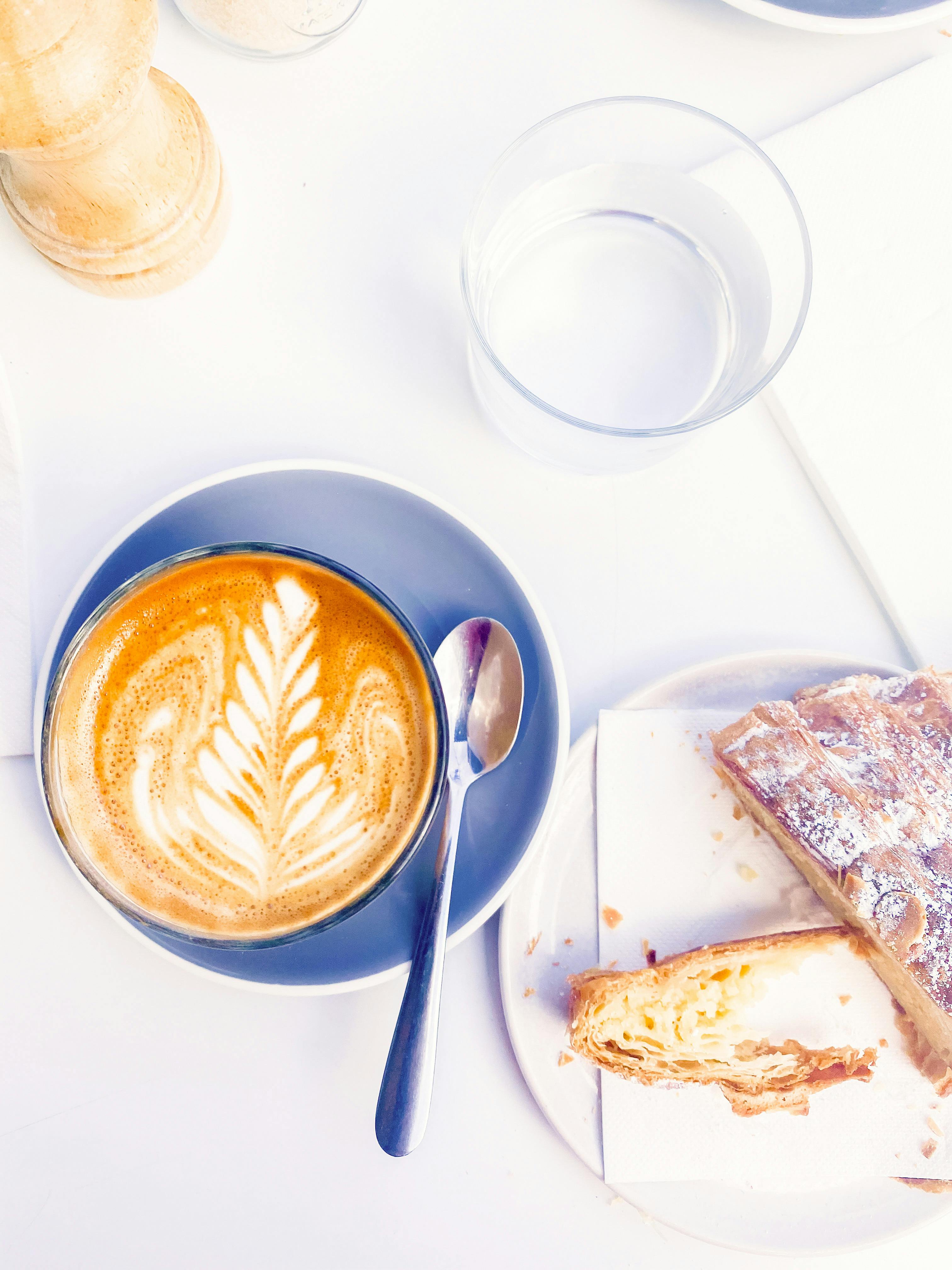 Photo of a Saucer with a Cup of Coffee and a Teaspoon · Free Stock Photo