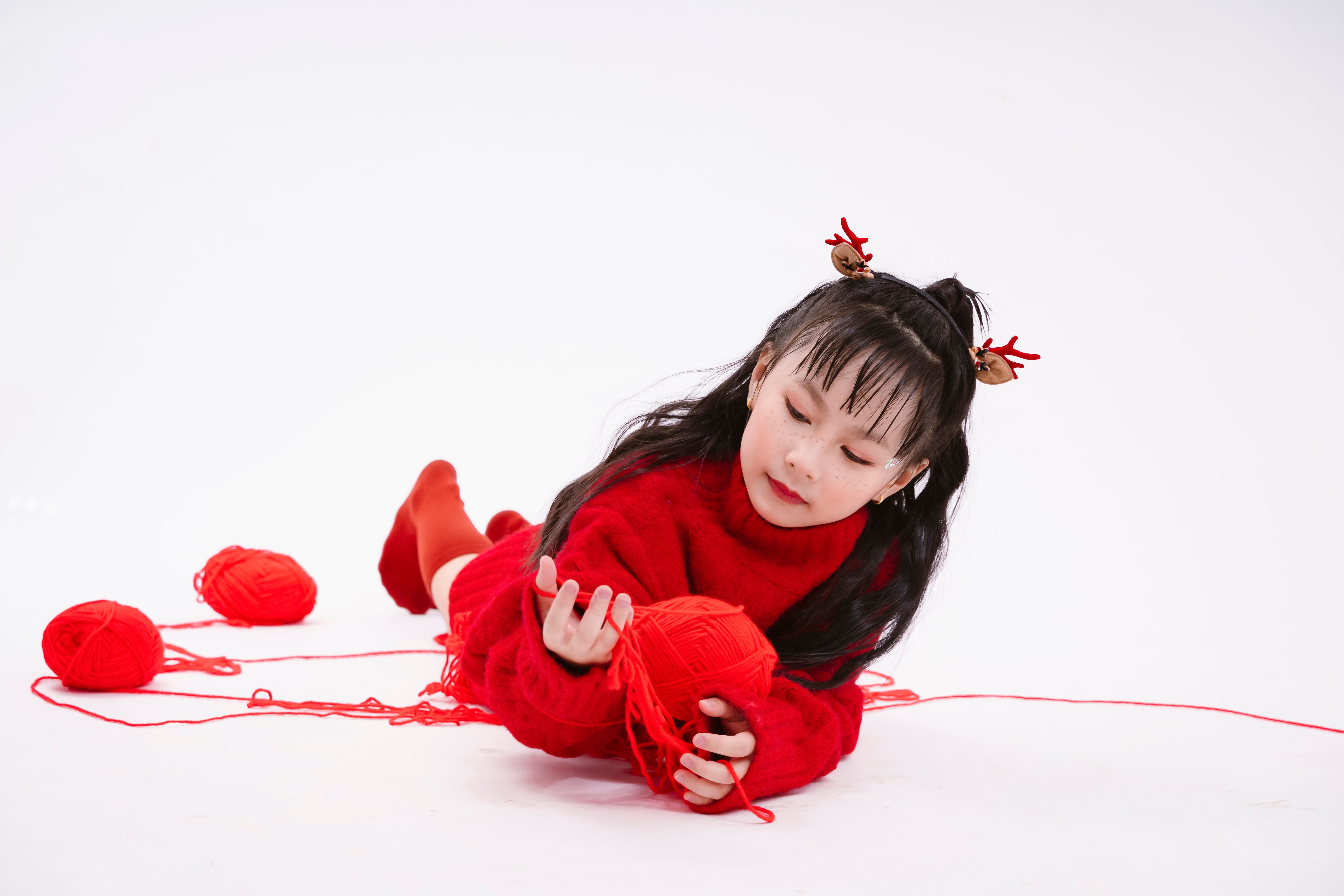 A Girl Holding a Ball of Yarn · Free Stock Photo