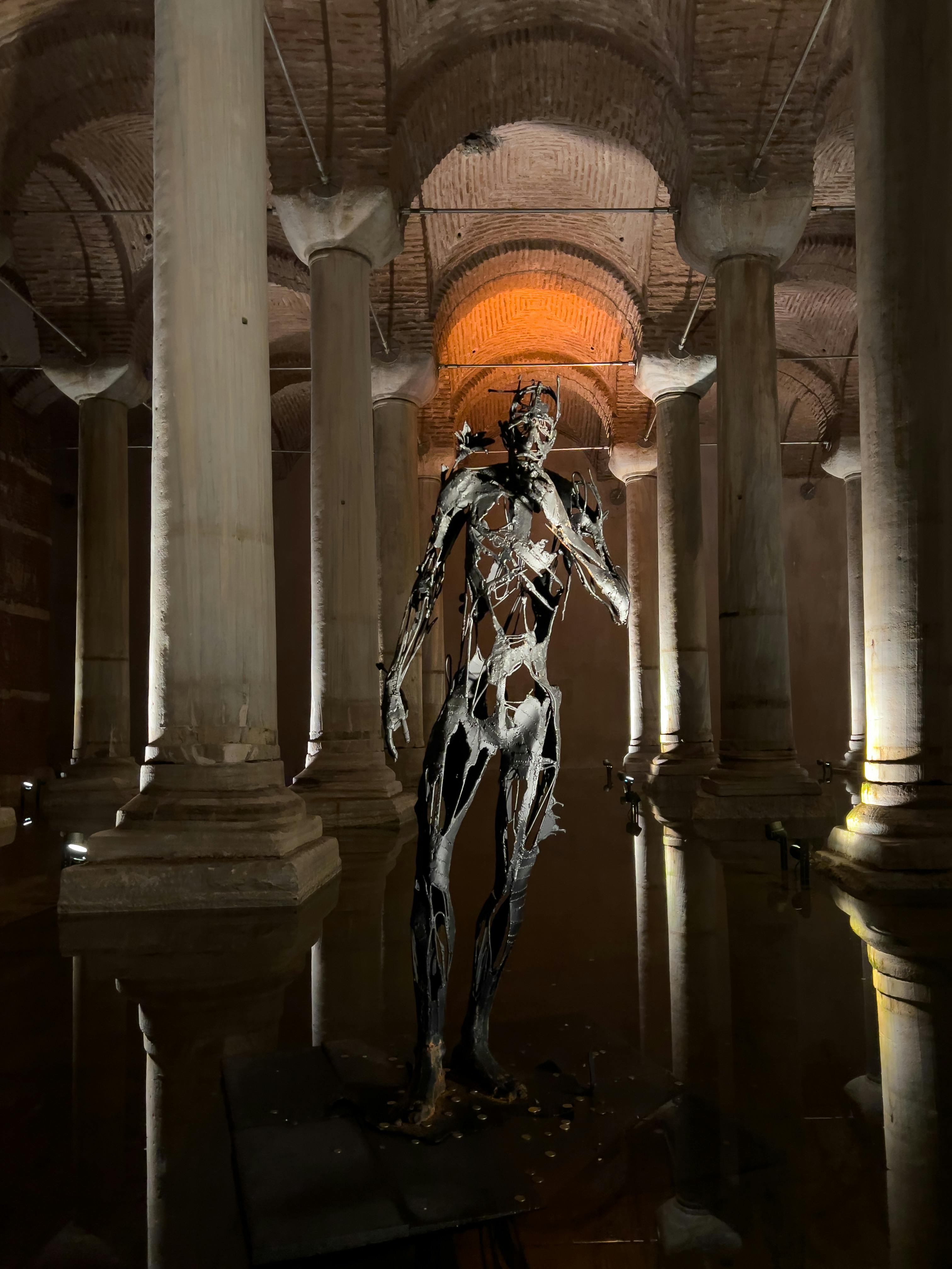 Spooky Metal Sculpture in a Cistern Interior with Arches and Columns ...